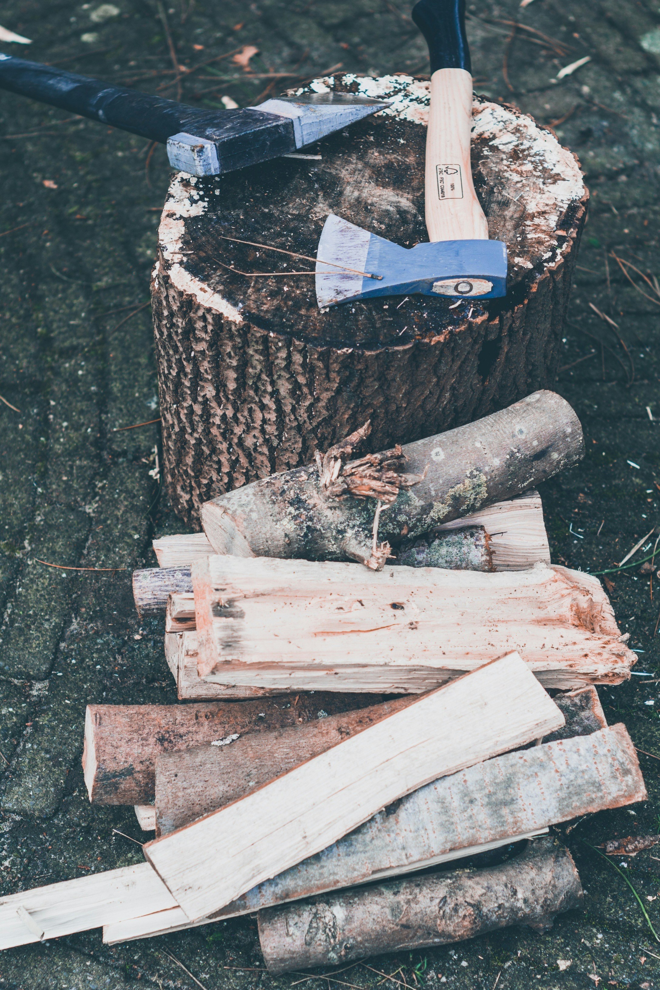 My pile of piled up lumber and wood block with axes.