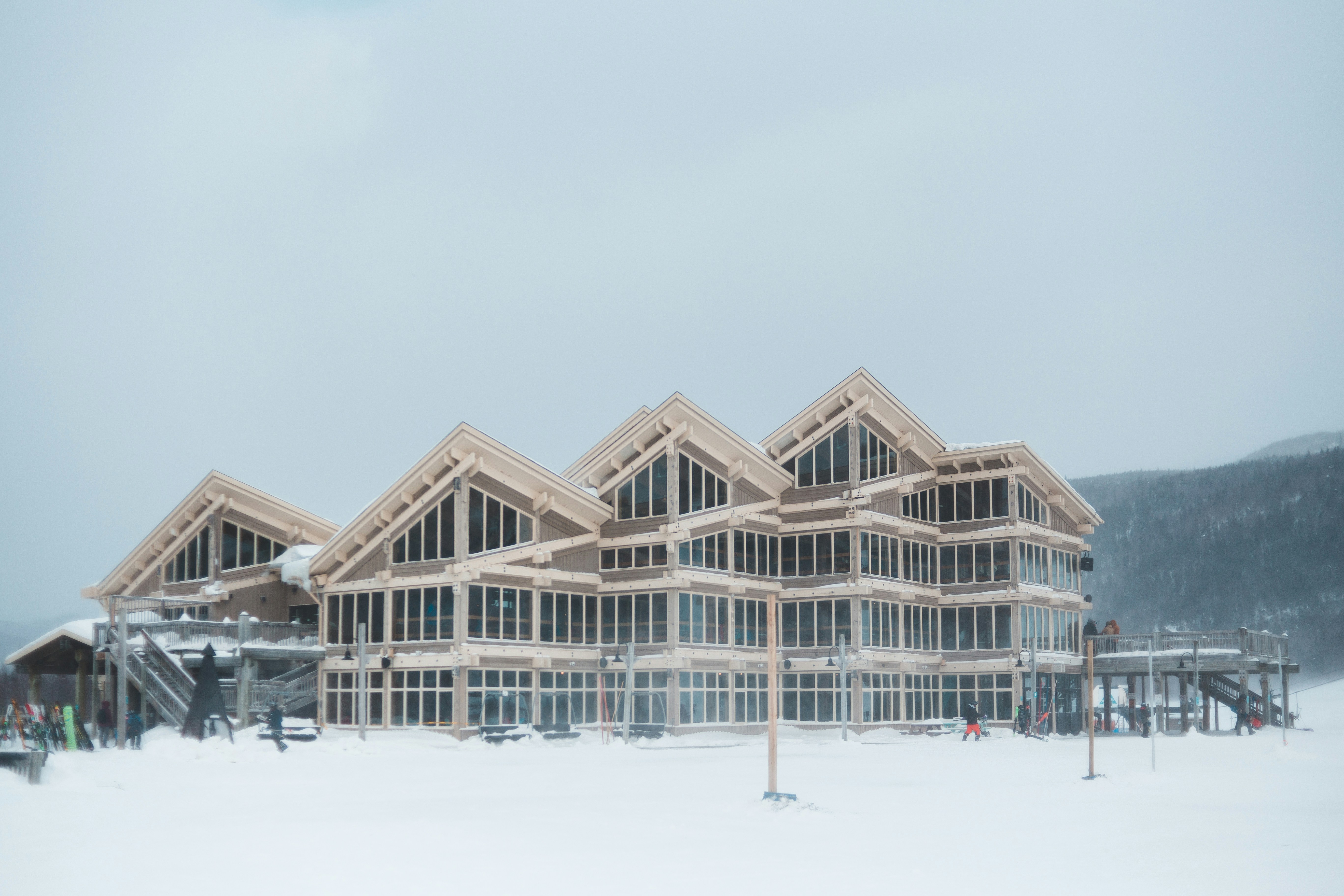 brown wooden houses on snow covered ground during daytime