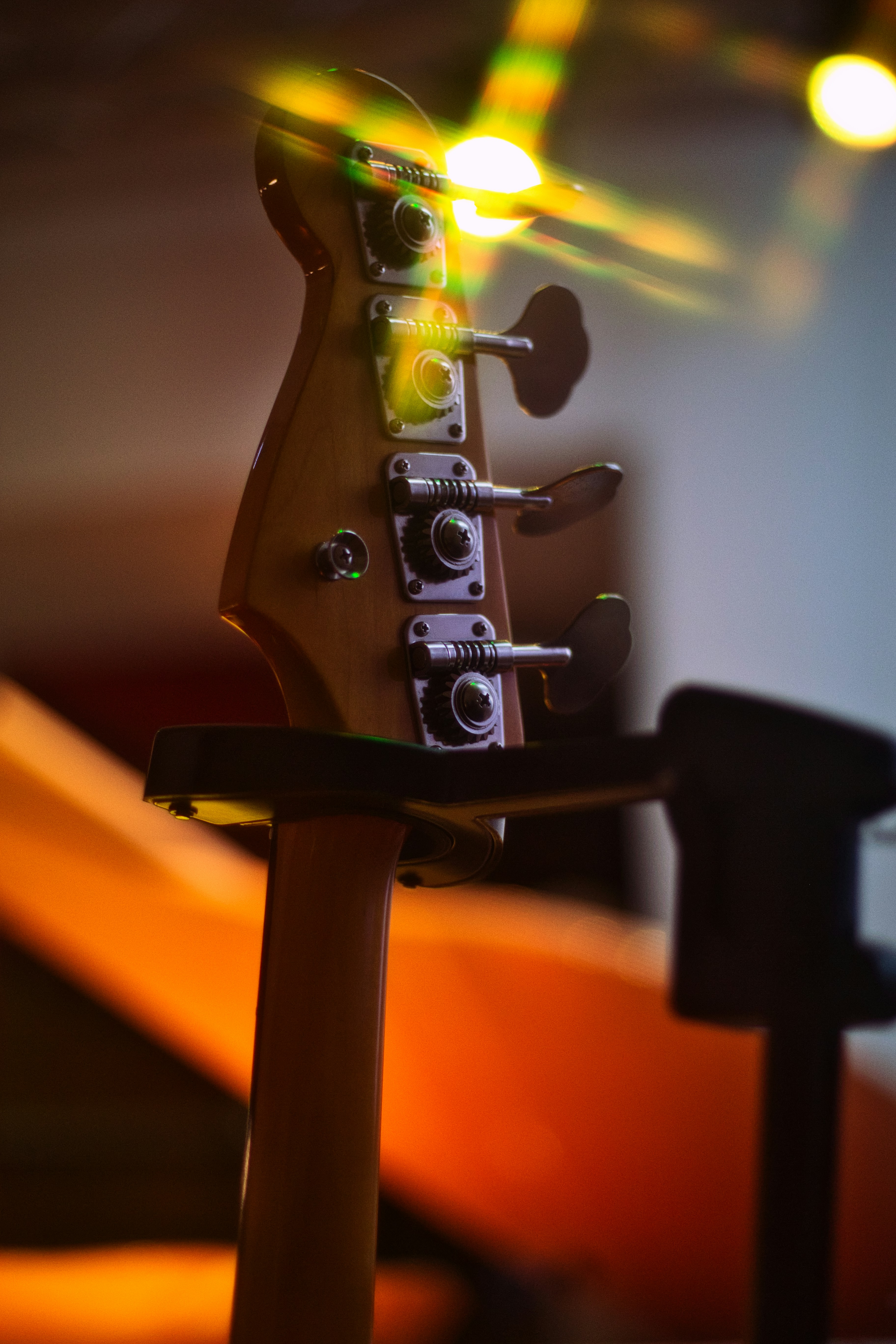 Backlit Guitar Headstock in Motion: Neon Glints on Tuning Pegs