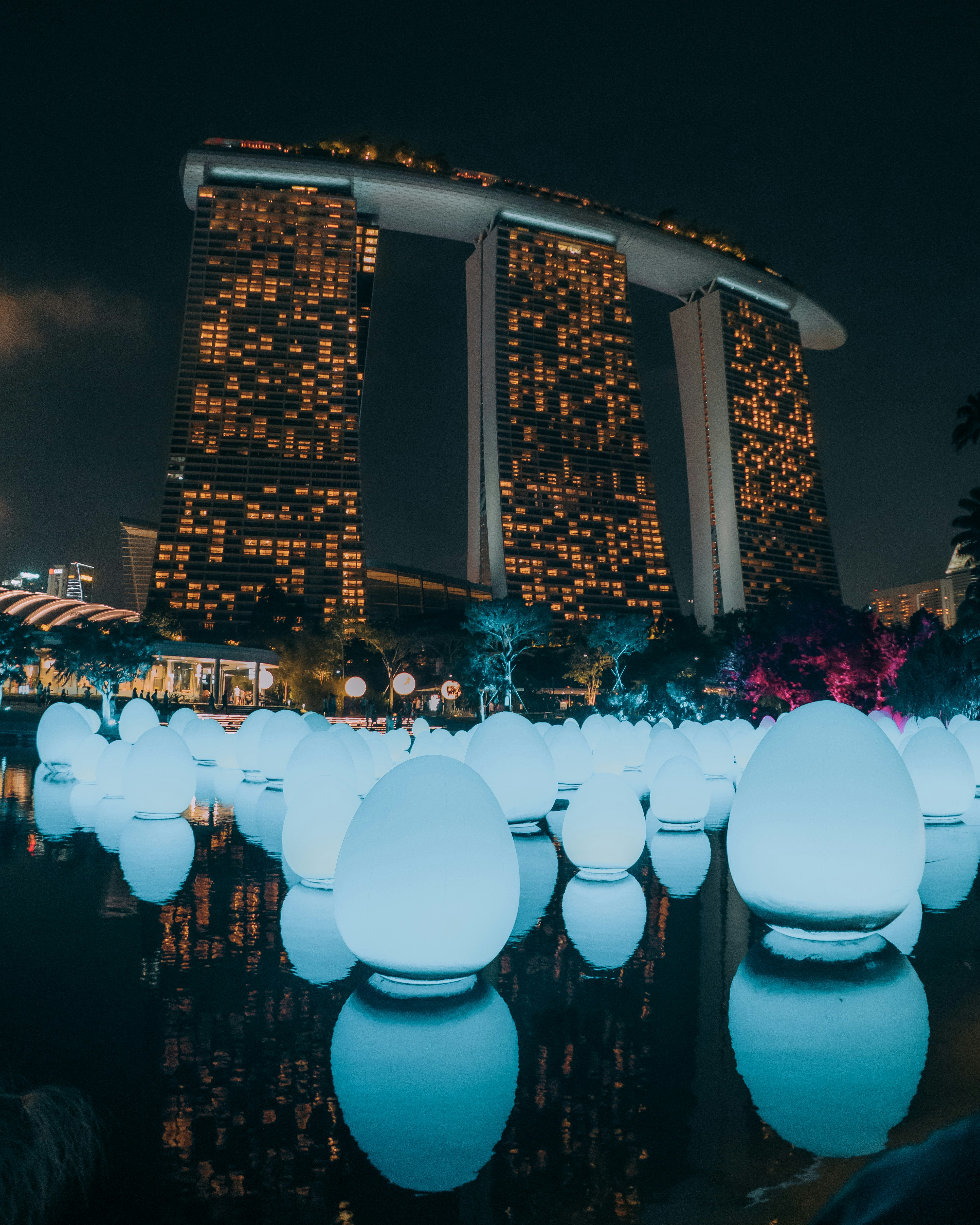 Blue Orbs on Night Water: Reflections Before Marina Bay Sands