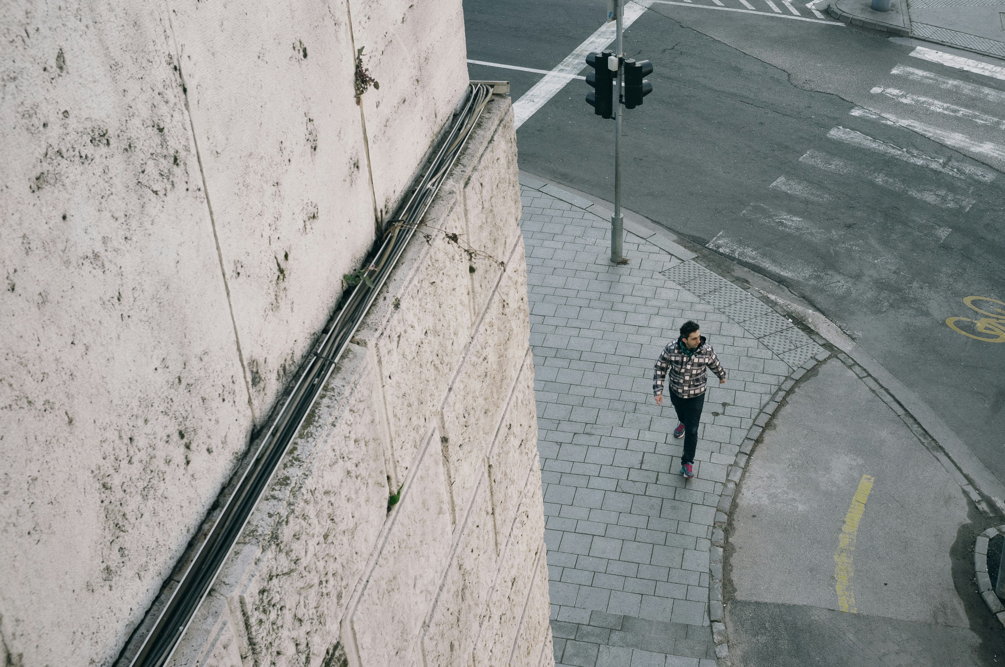 Woman in black and white dress walking on sidewalk during daytime photo ...