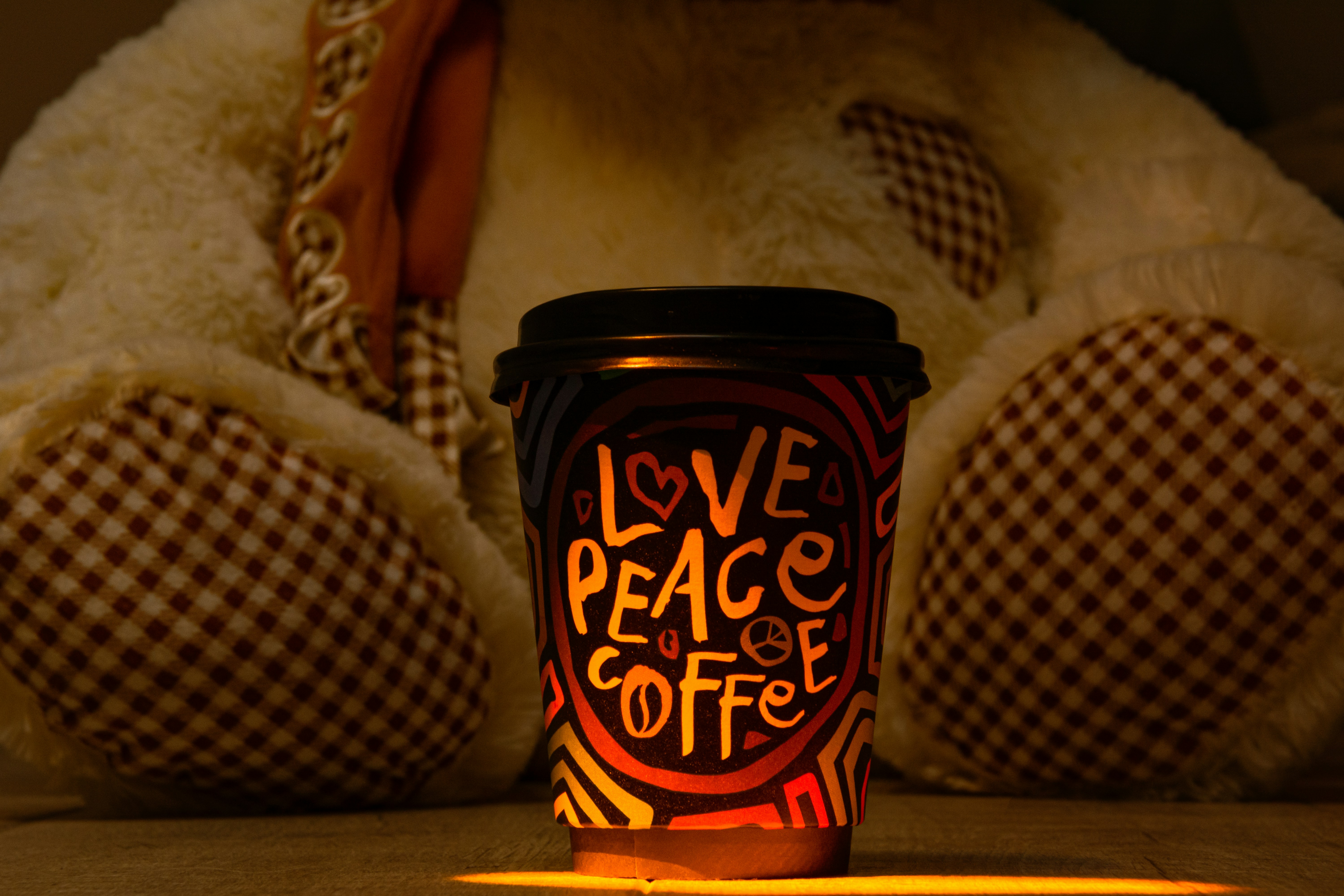 Graffiti-to-Go: A Colorful Coffee Cup Under a Warm Spotlight