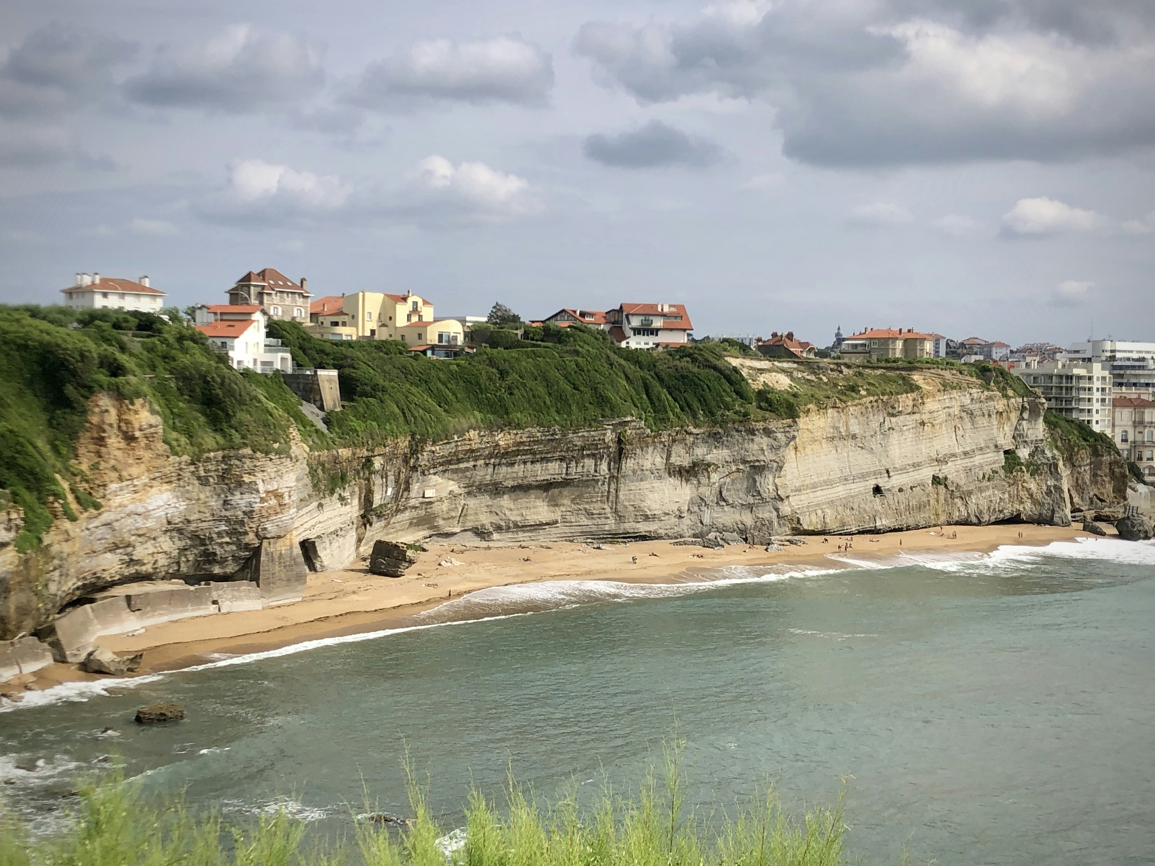 Pastel Rooftops on a Windswept Cliffline