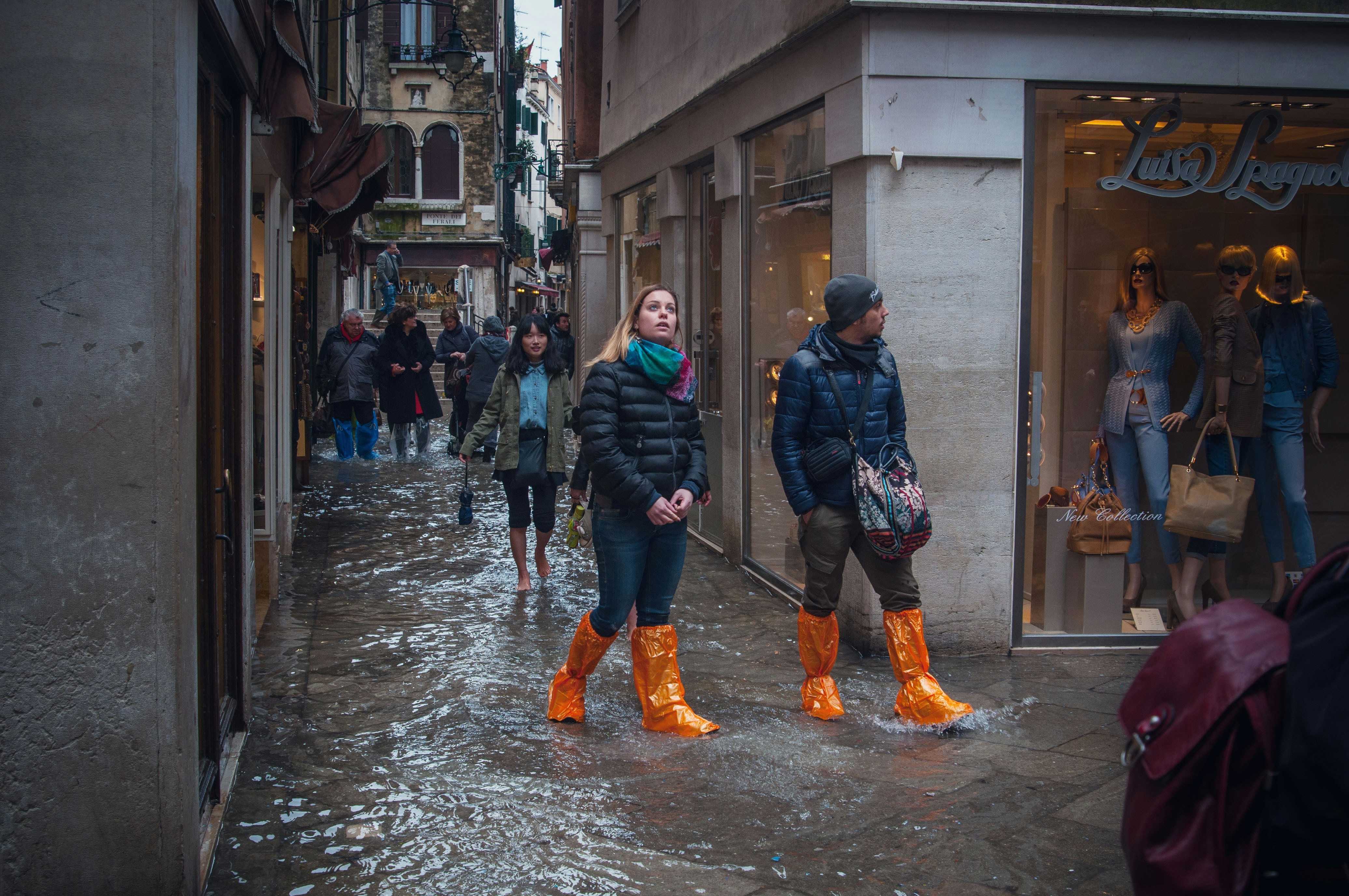 Orange Boots on a Flooded City Lane
