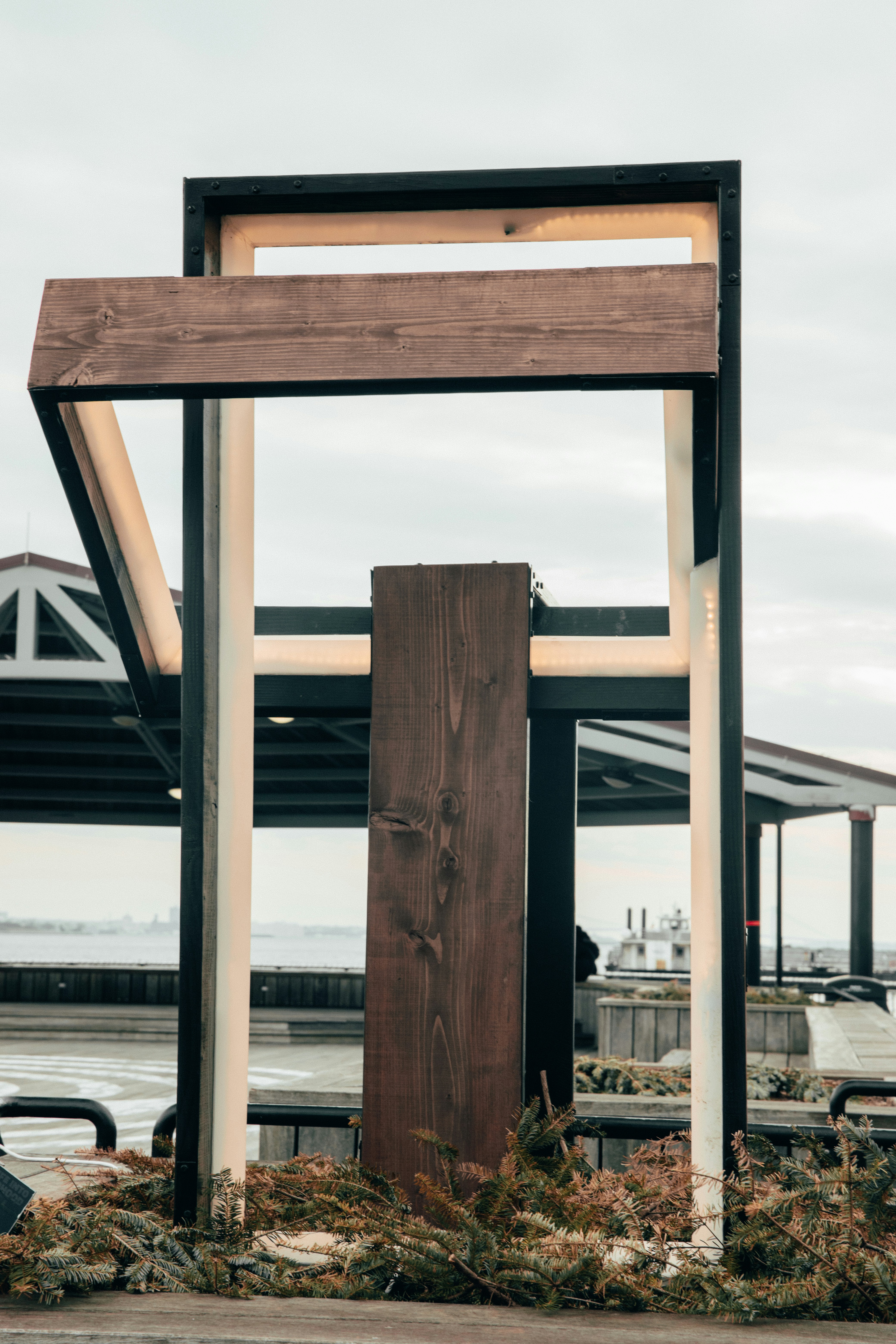 Harbor Frames: Weathered Timber Nestled in Industrial Geometry