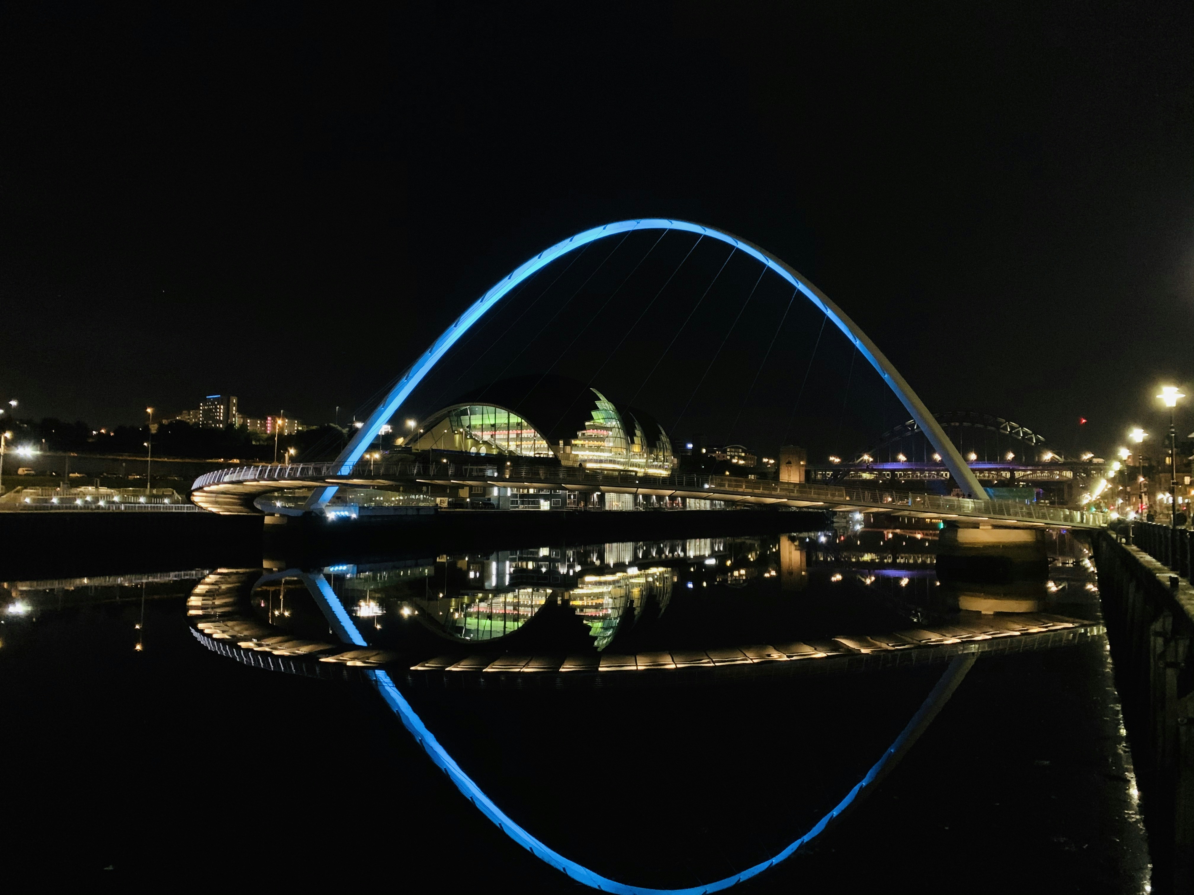 Lighted bridge over river during night time photo – Free City Image on ...