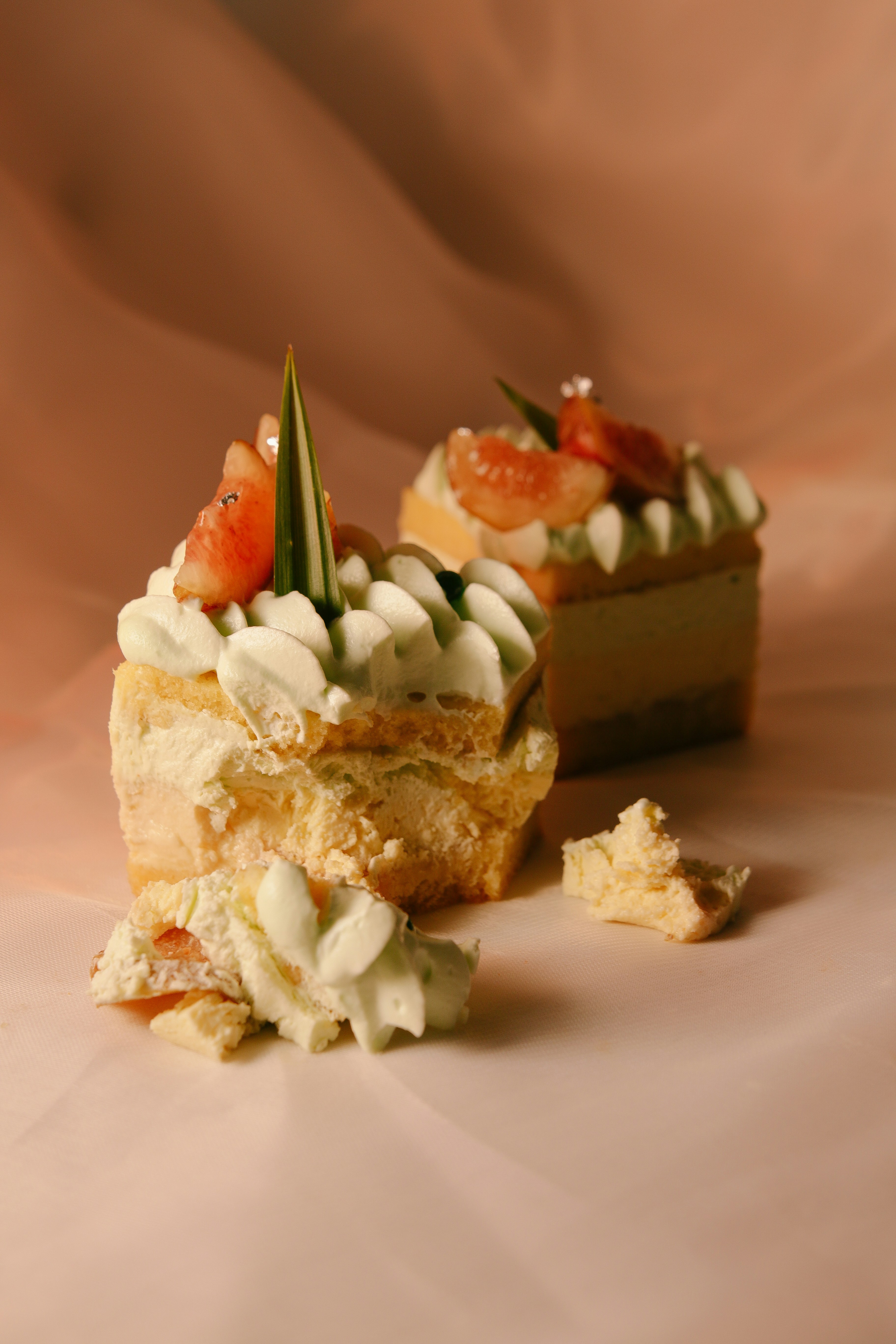 Cream-Topped Petit Cakes on Peach Satin