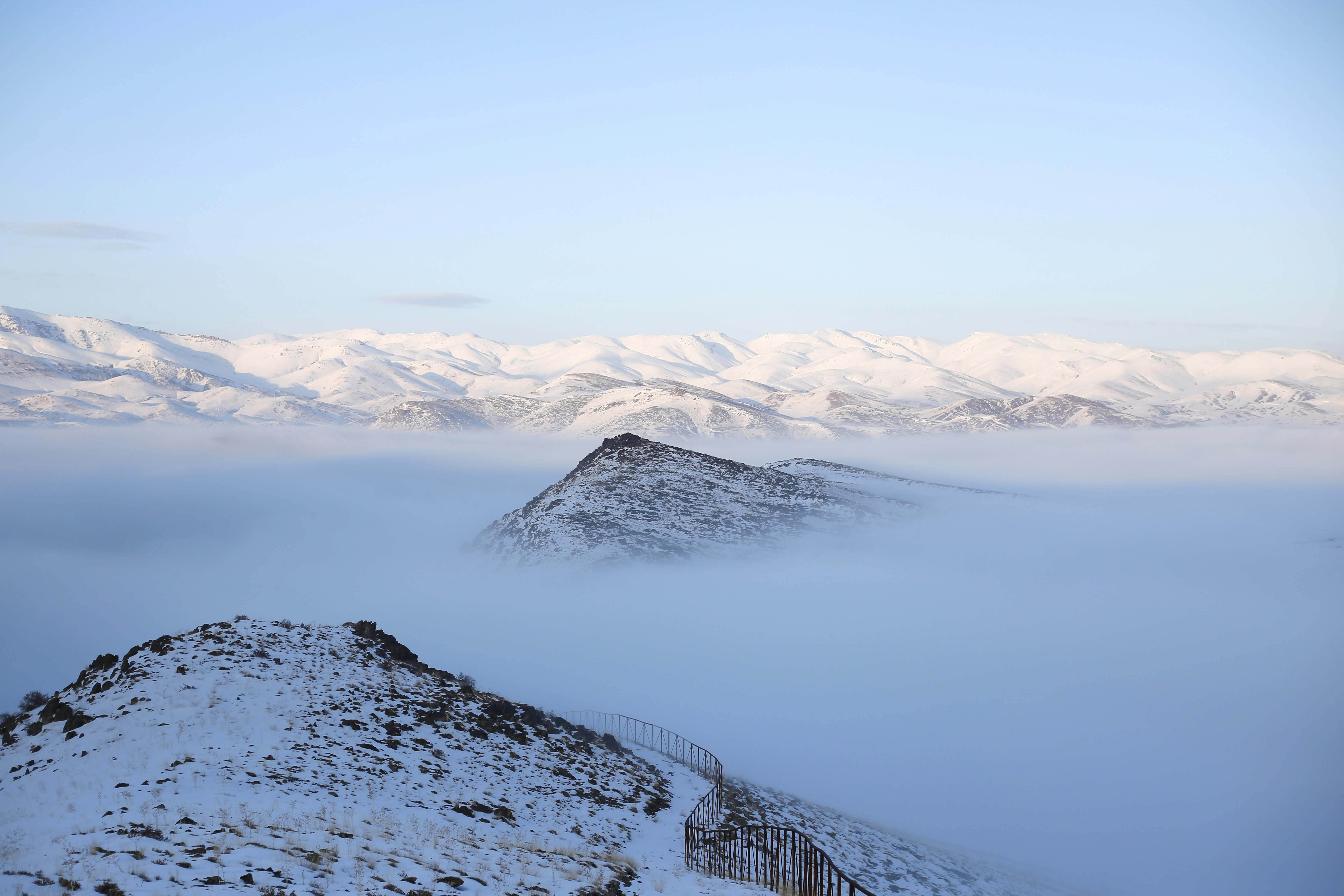 Snowbound Ridge Pierces a Sea of Clouds at Dawn