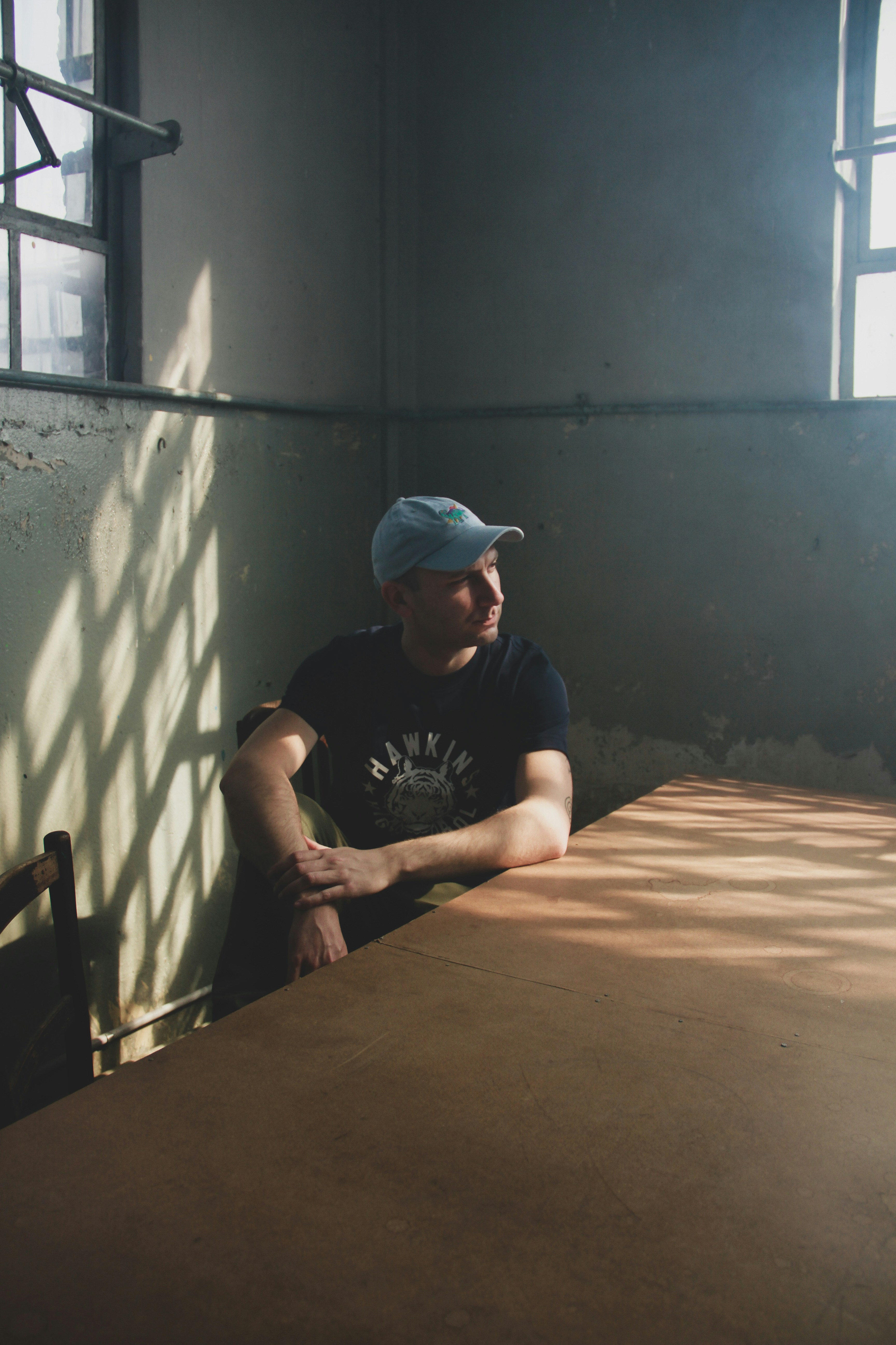 Stripes of Light: Quiet Portrait at a Weathered Table