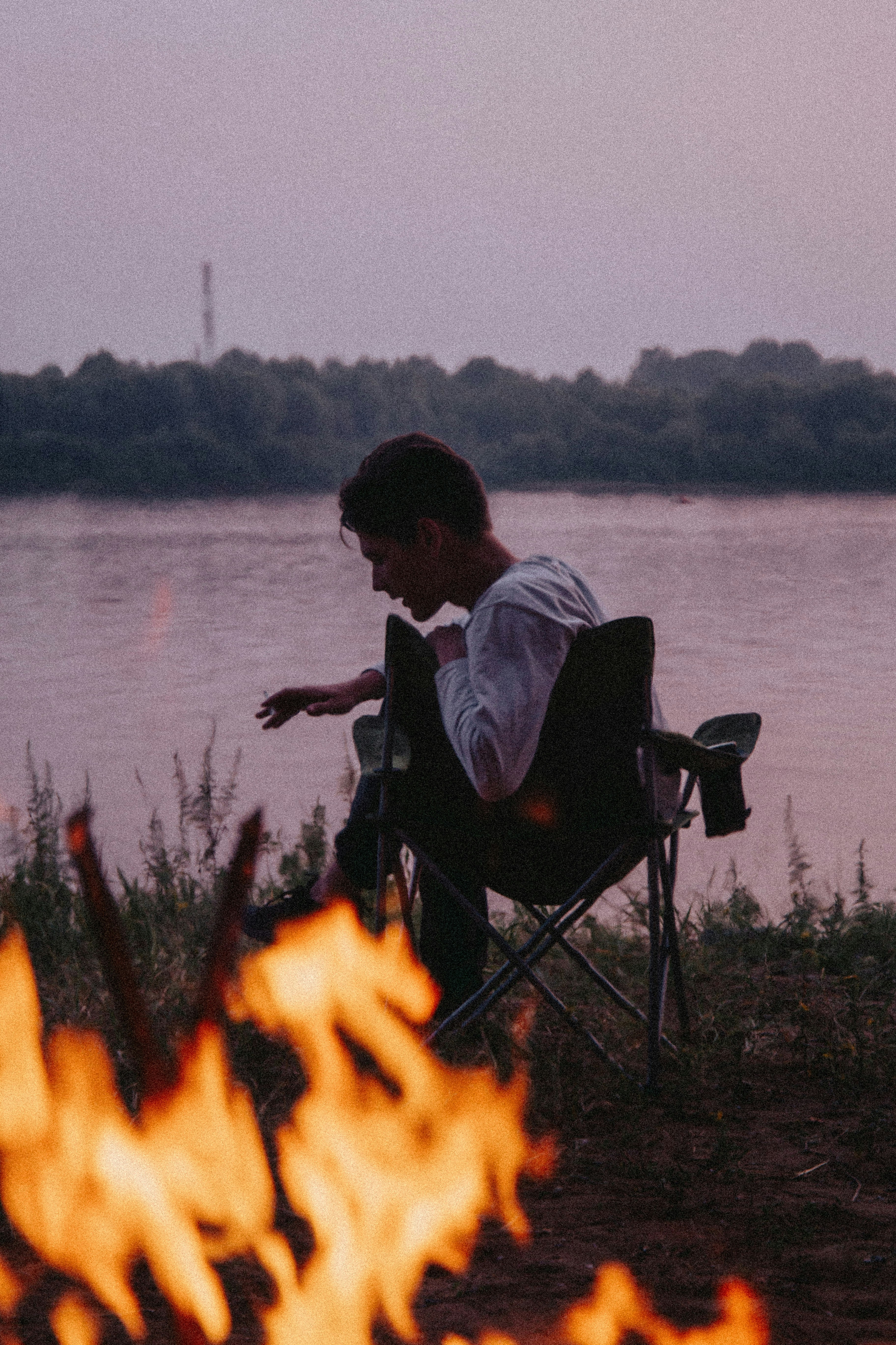 Quiet Campfire Portrait by the River at Dusk