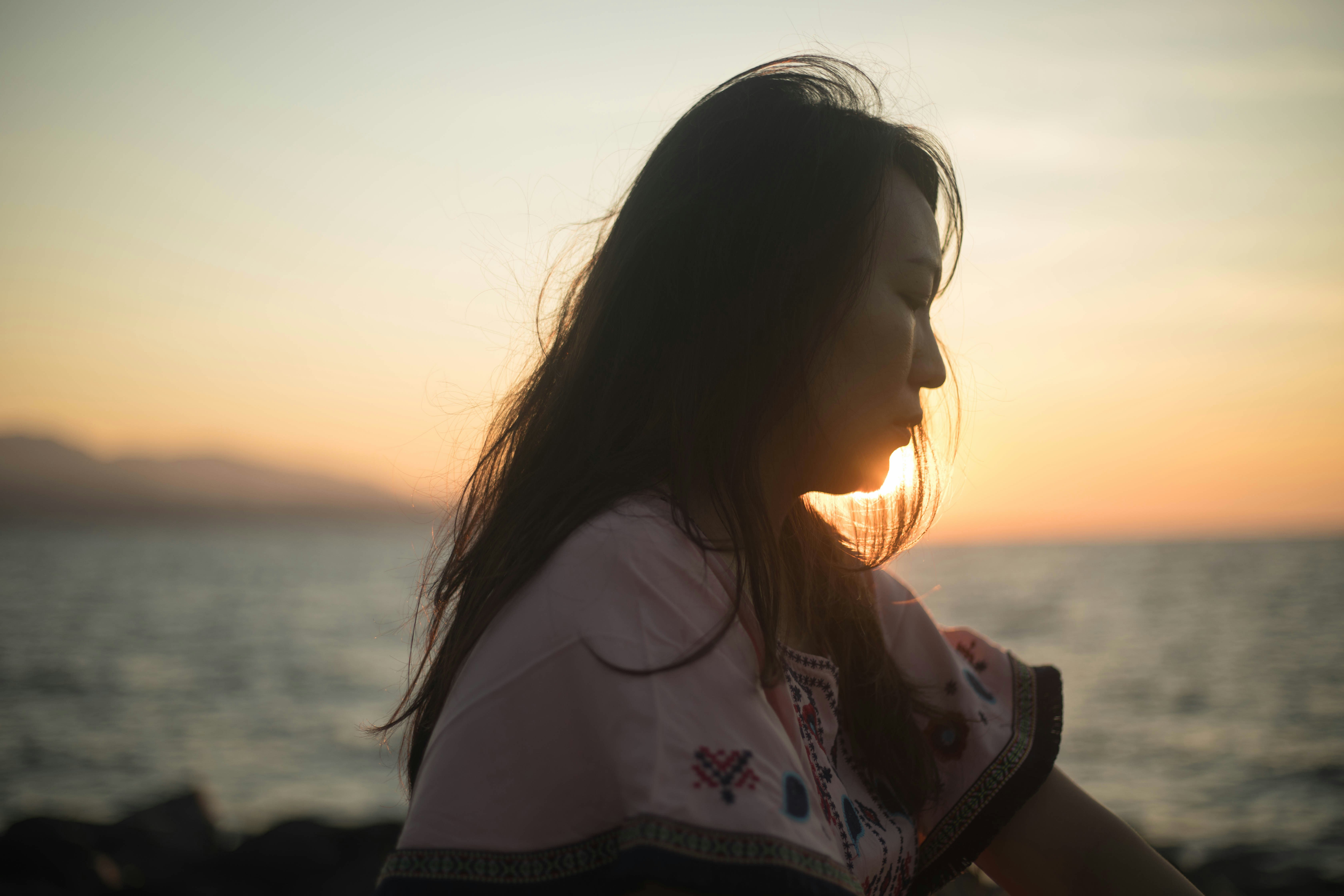 Woman in white shirt holding smartphone during sunset photo – Free ...