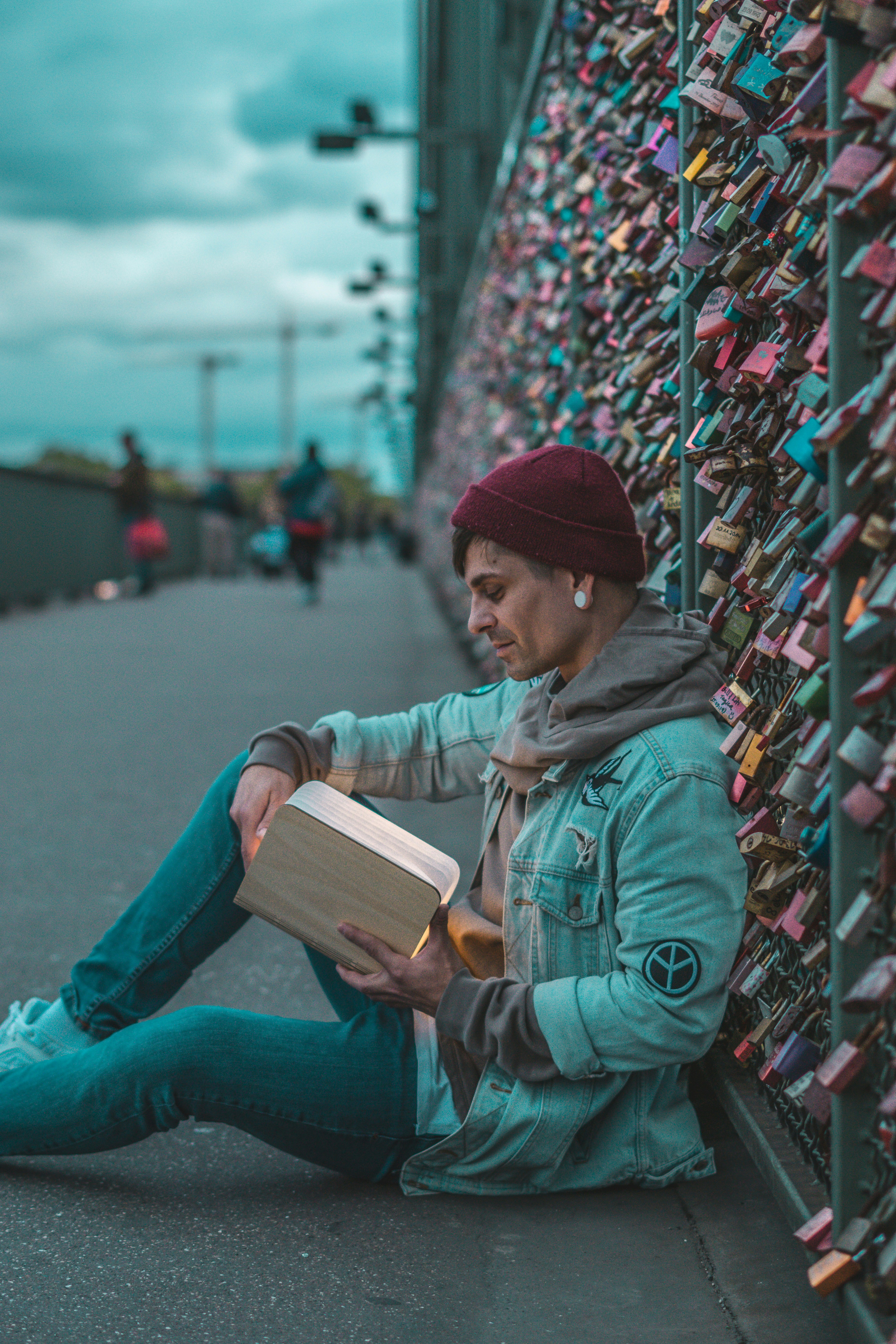 Reader in the Alley: A Portrait Amid Locks and Neon Blues