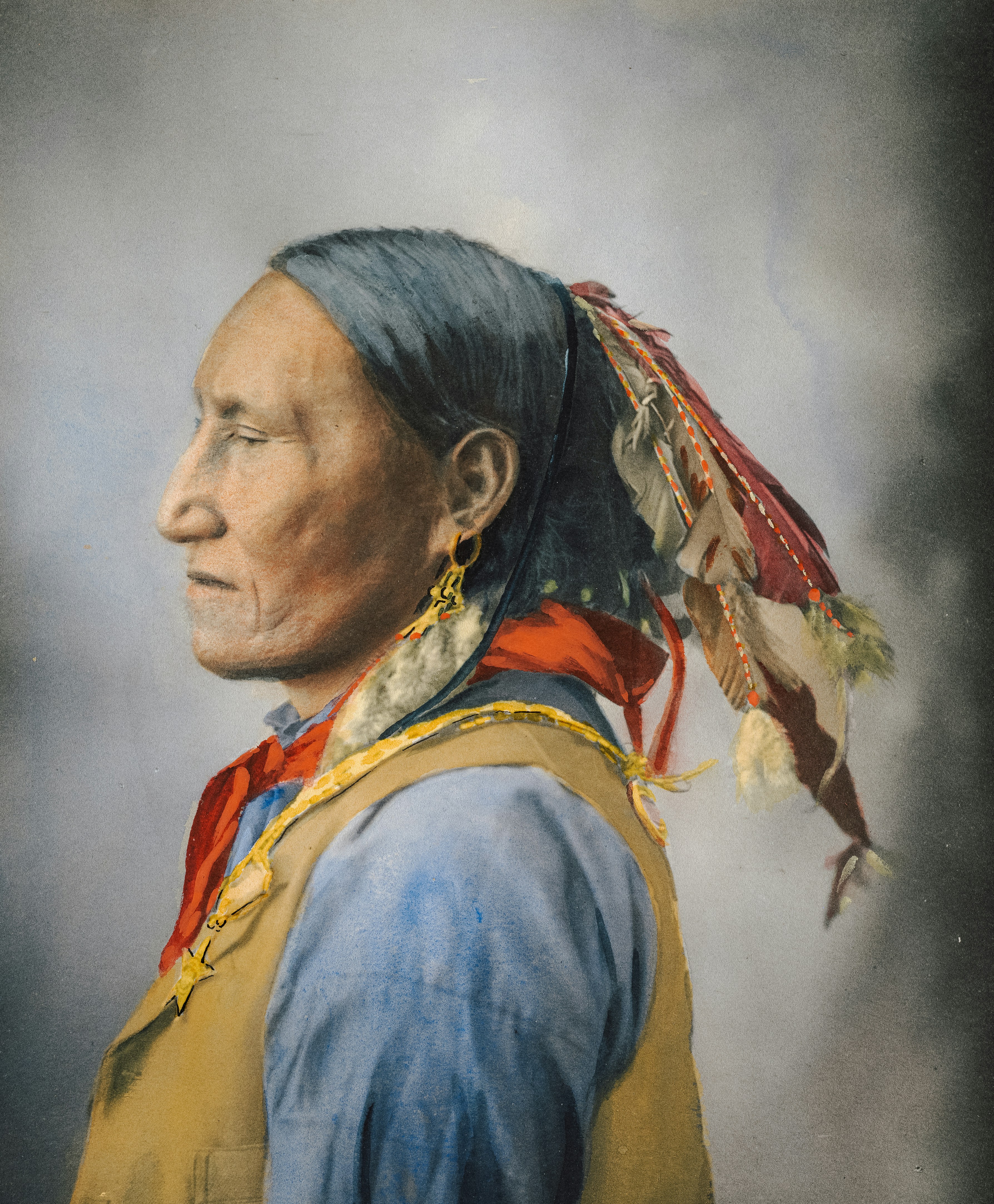 Profile of a Native American man adorned with traditional attire and accessories, showcasing cultural pride and history.