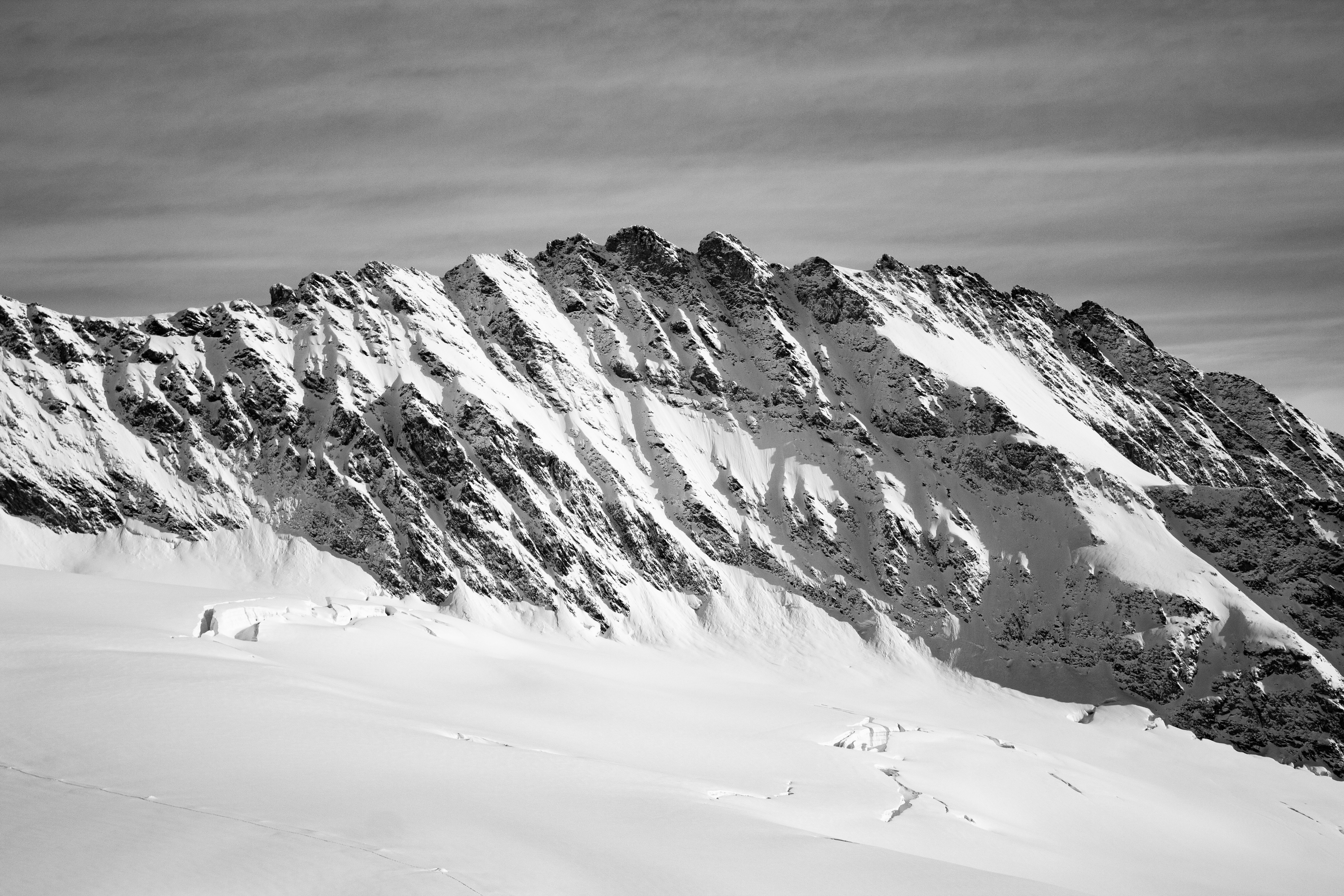 Snow covered mountain under cloudy sky during daytime photo – Free ...