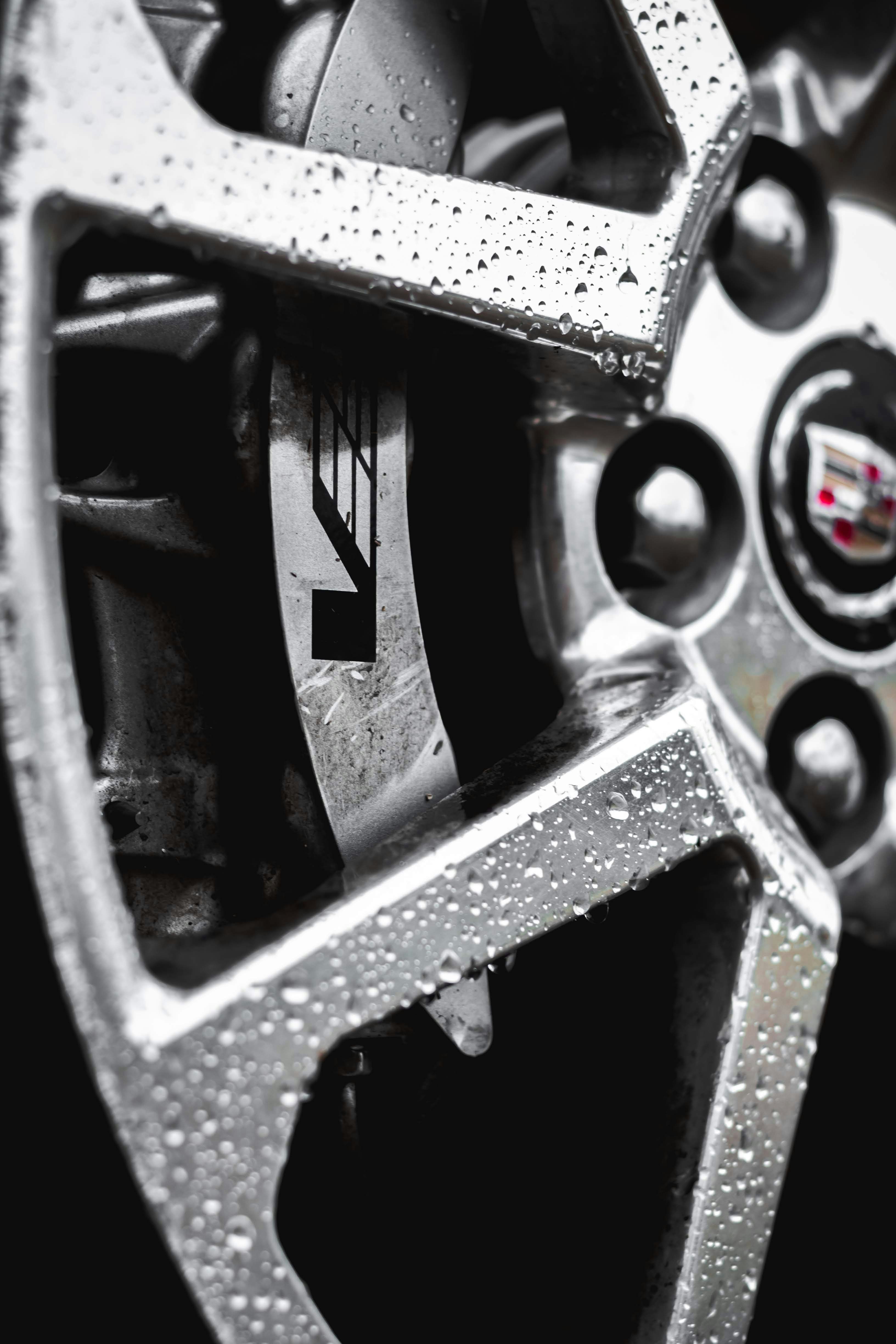 Rain-Kissed Alloy: Close-Up on a Wheel's Quiet Geometry