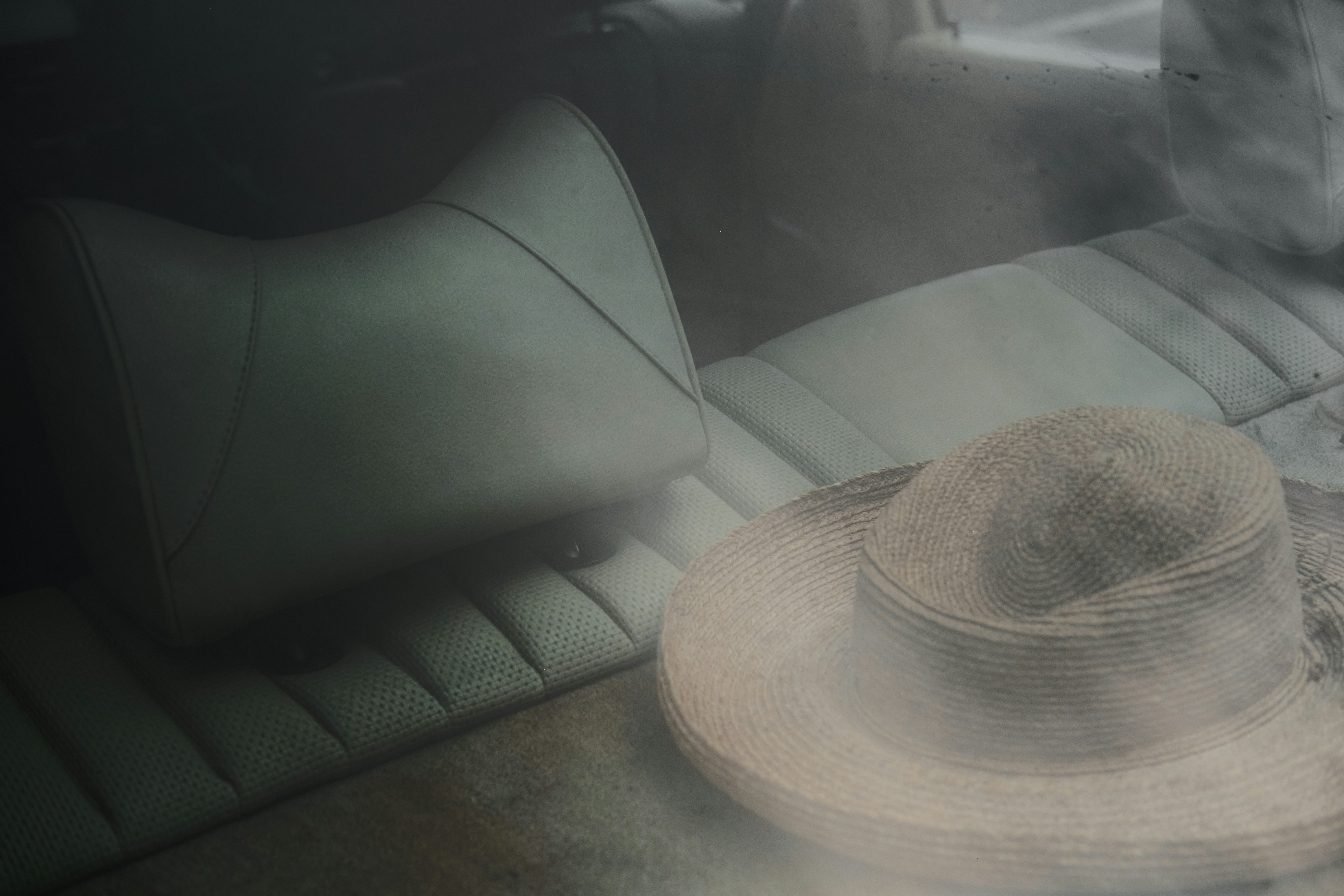 brown fedora hat on car seat