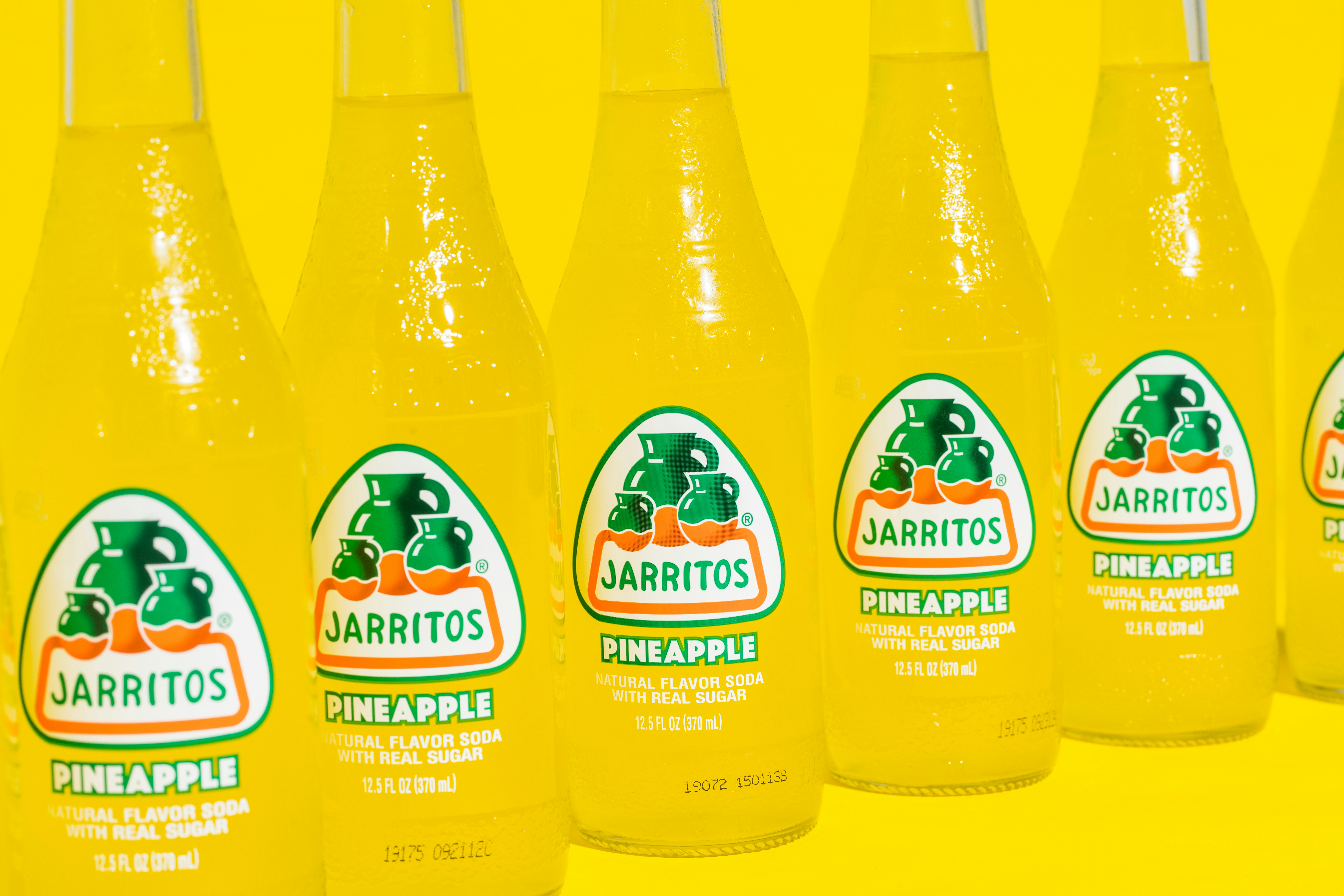 Pineapple Parade: A Studio Row of Jarritos Bottles in Luminous Yellow