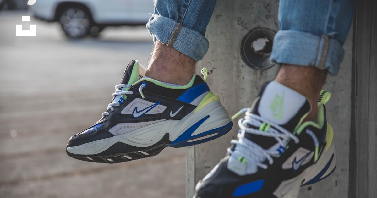 Person Wearing Blue White And Green Nike Athletic Shoes Photo Free
