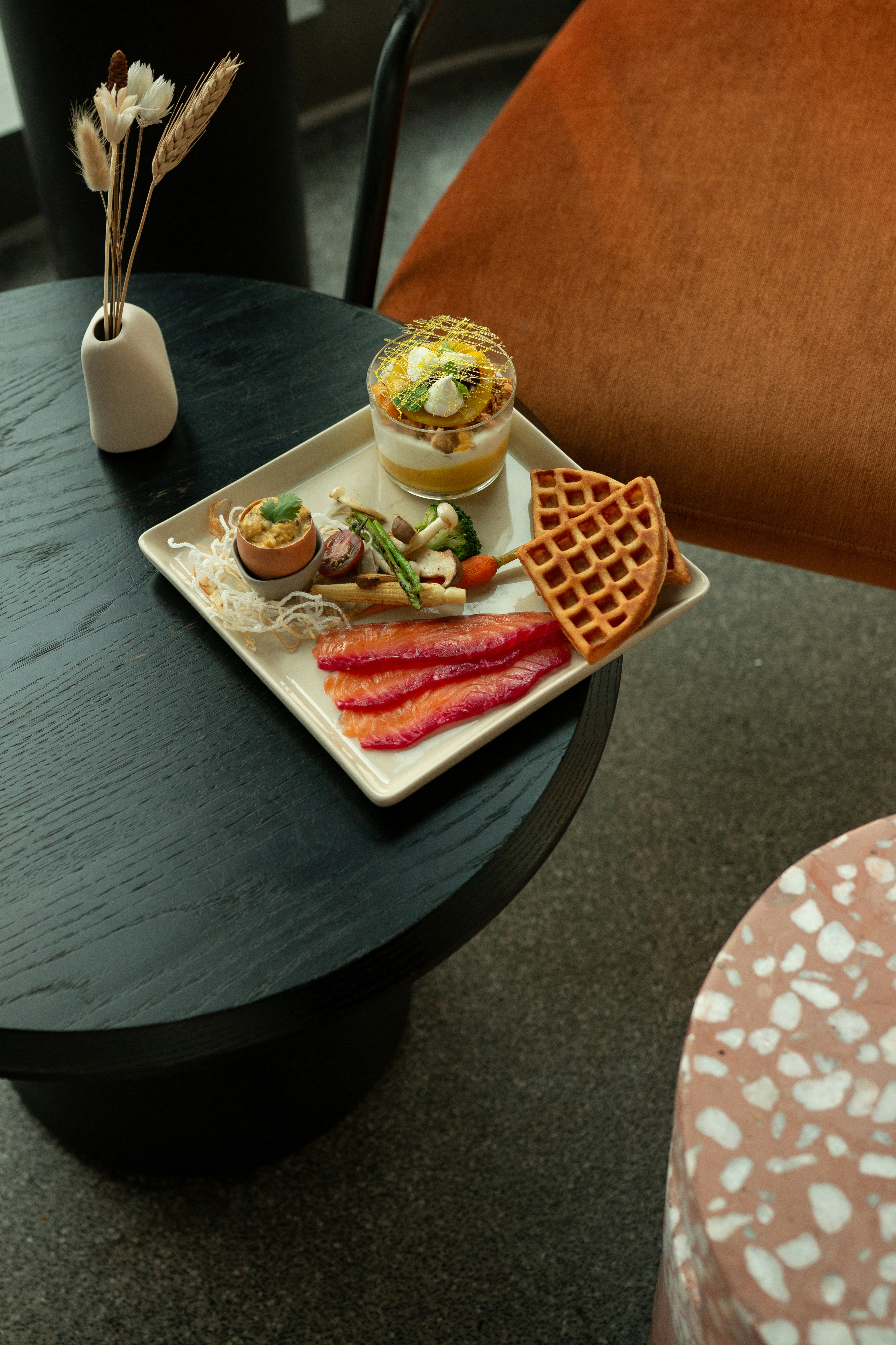 Glass Parfait Crowned with Crunch: A Petite Dessert Ensemble on a Dark Table
