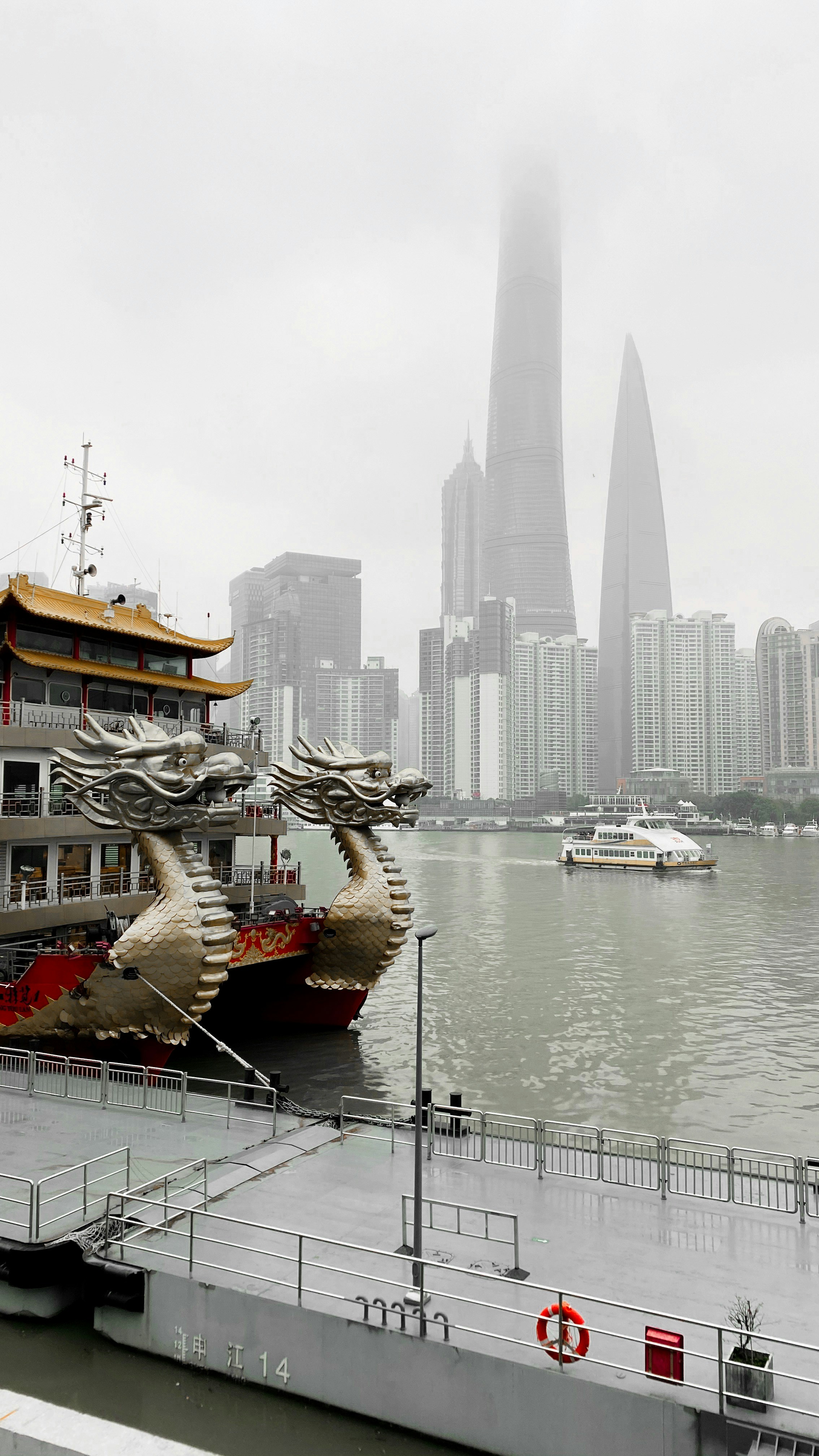brown and white boat on water near city buildings during daytime