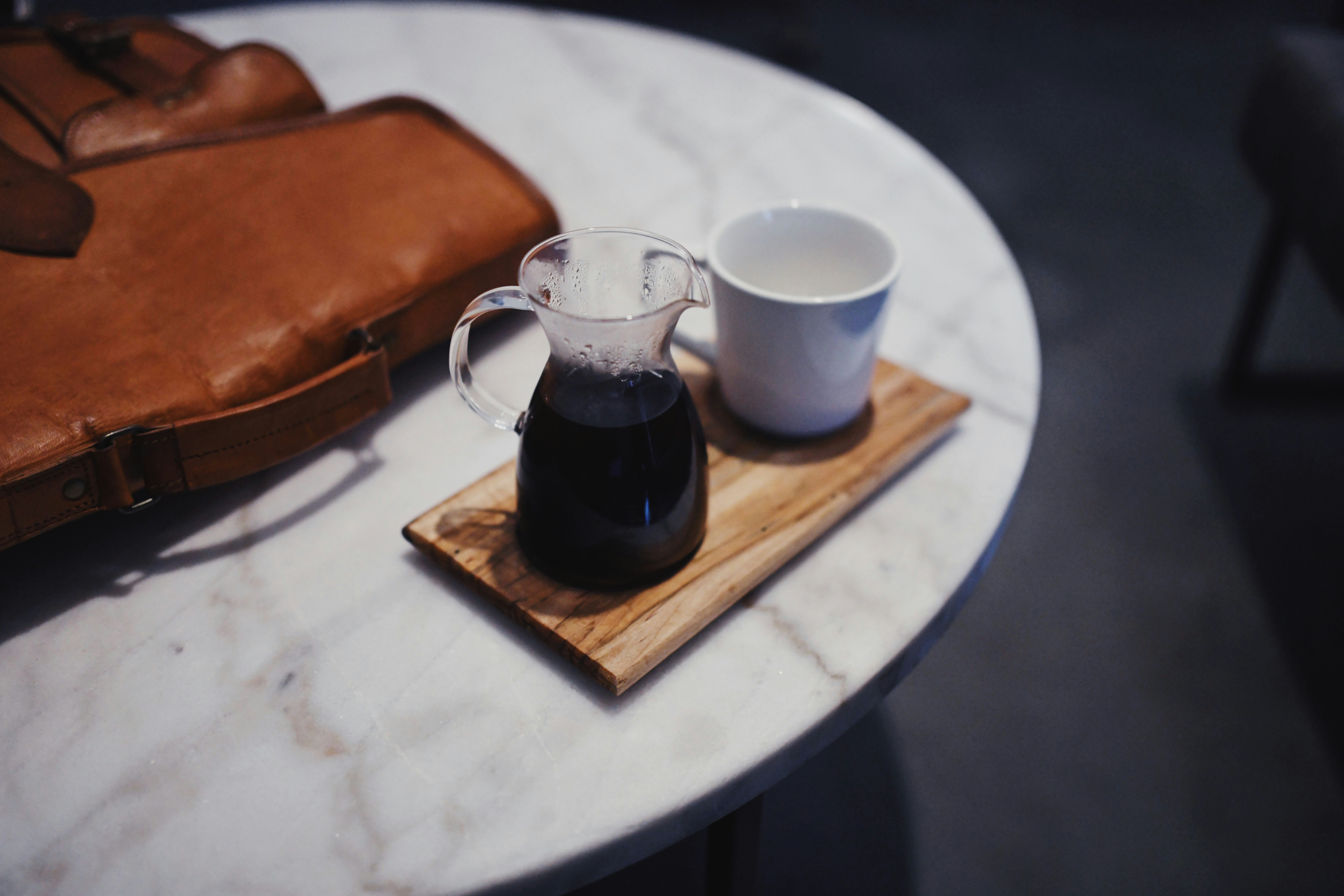 Glass Carafe on Marble: A Quiet Morning with Leather and Steam