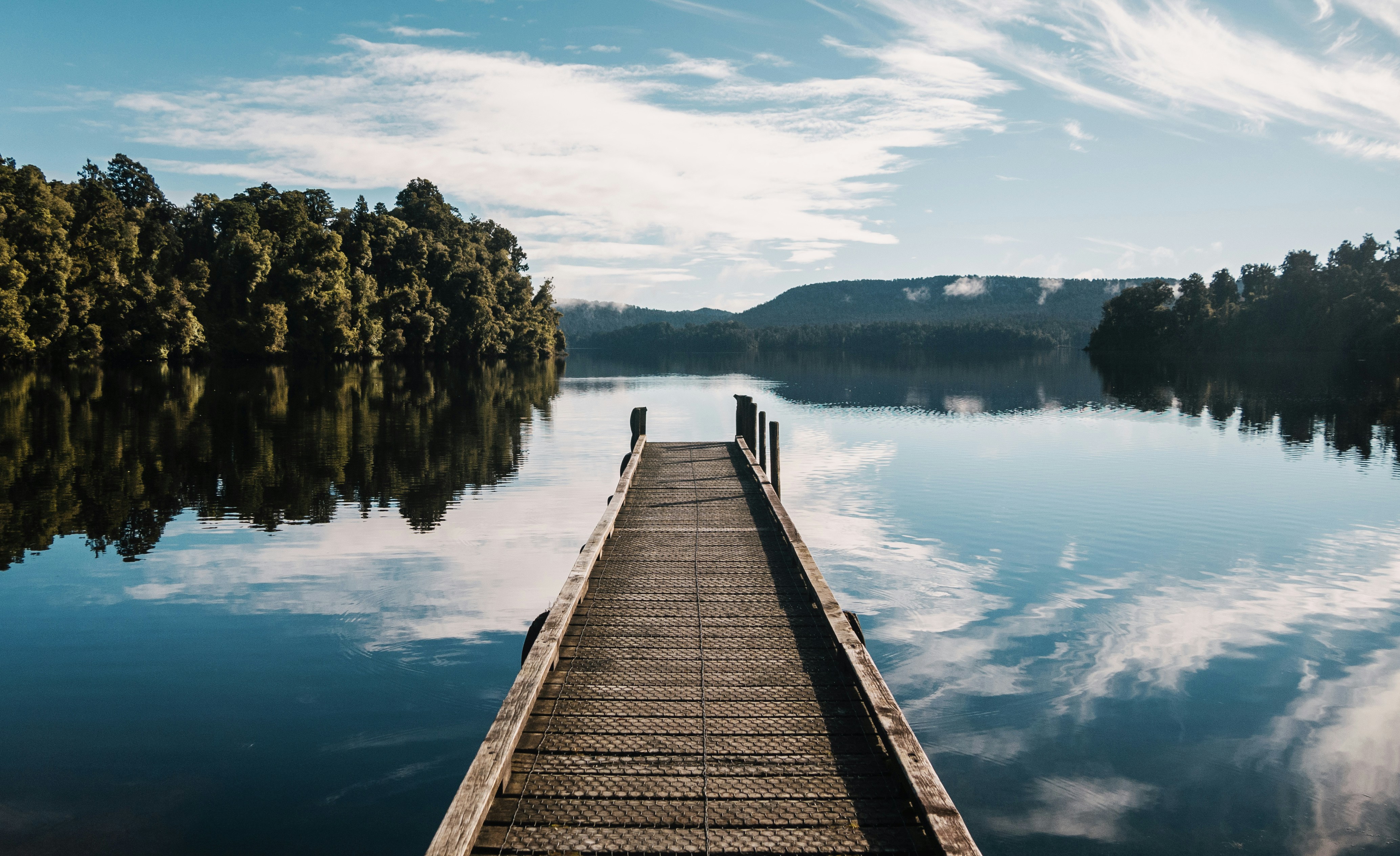 Lake pier in New Zeland | brown wooden dock on lake during daytime