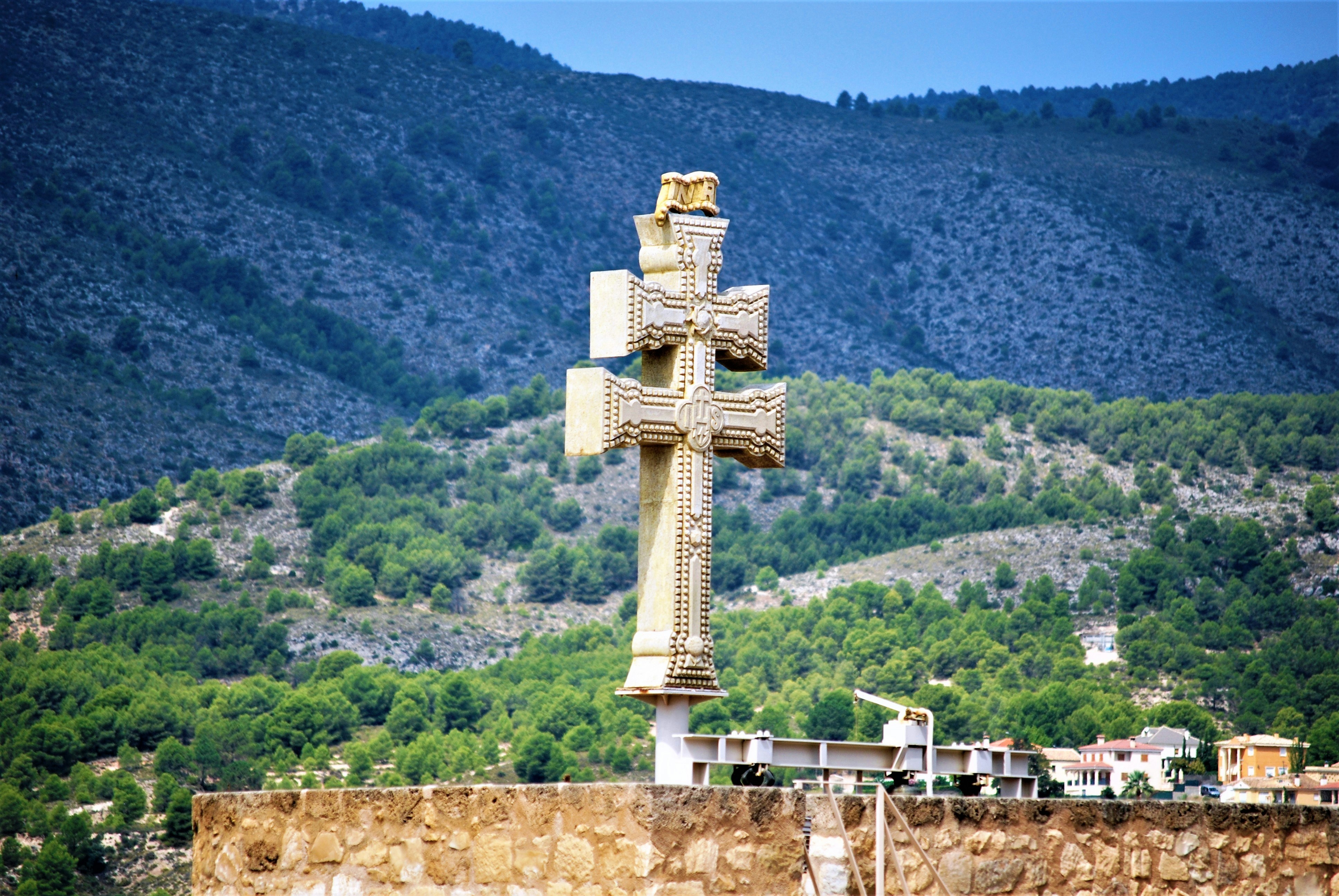 Hilltop Cross: Weathered Monument Standing Watch Over a Quiet Valley