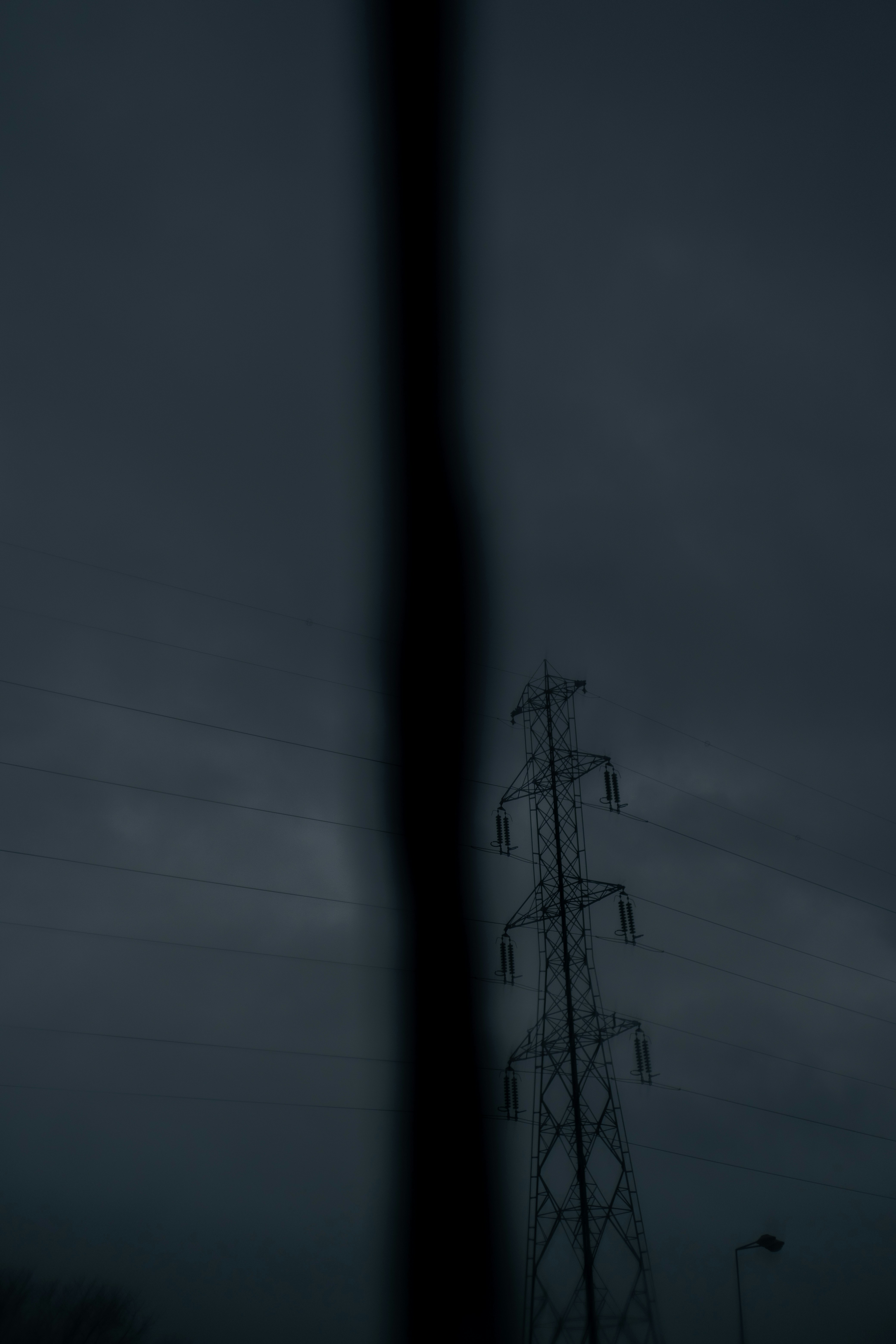 black electric post under gray sky