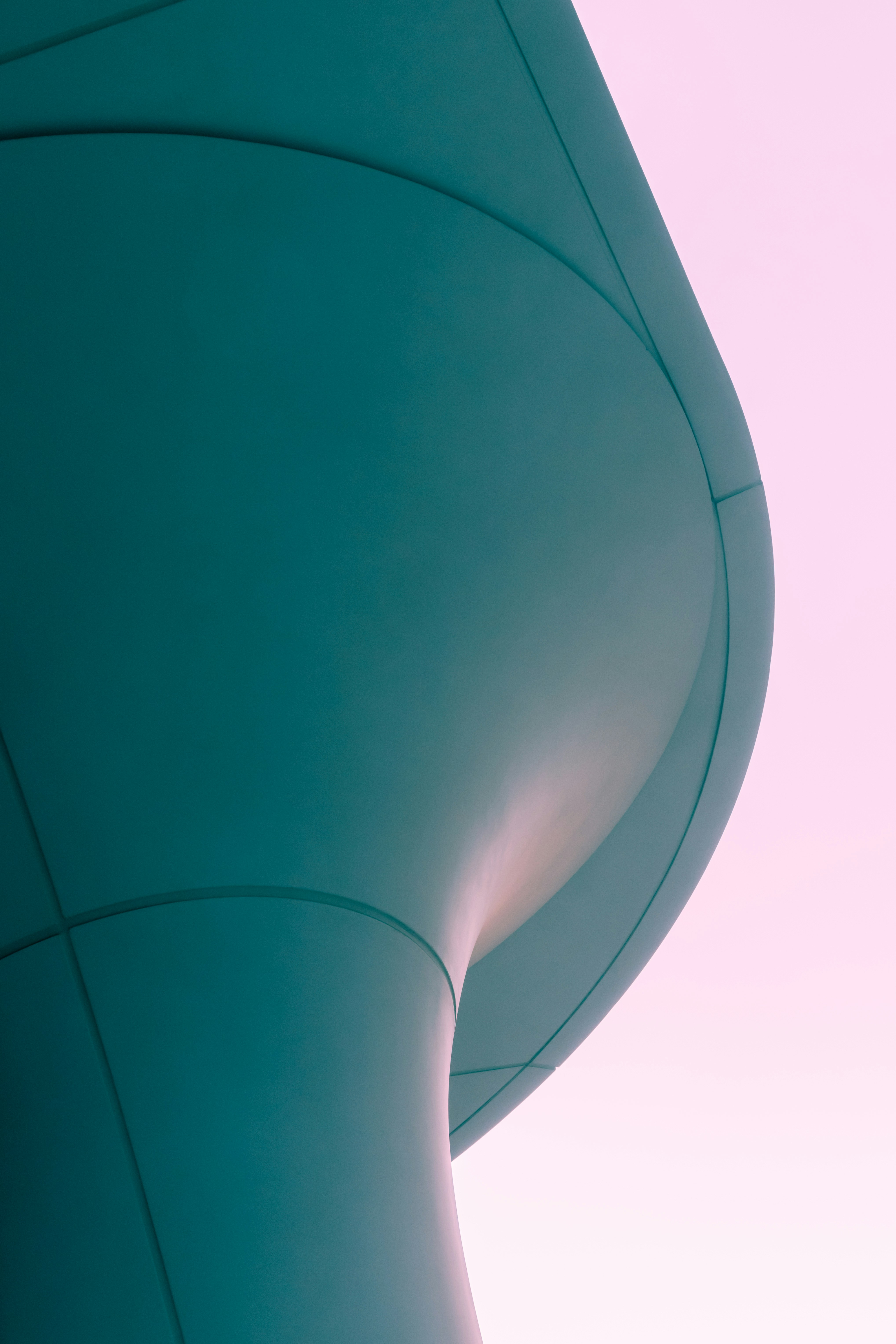 Teal Curve Against a Blush Backdrop: A Minimalist Architectural Portrait