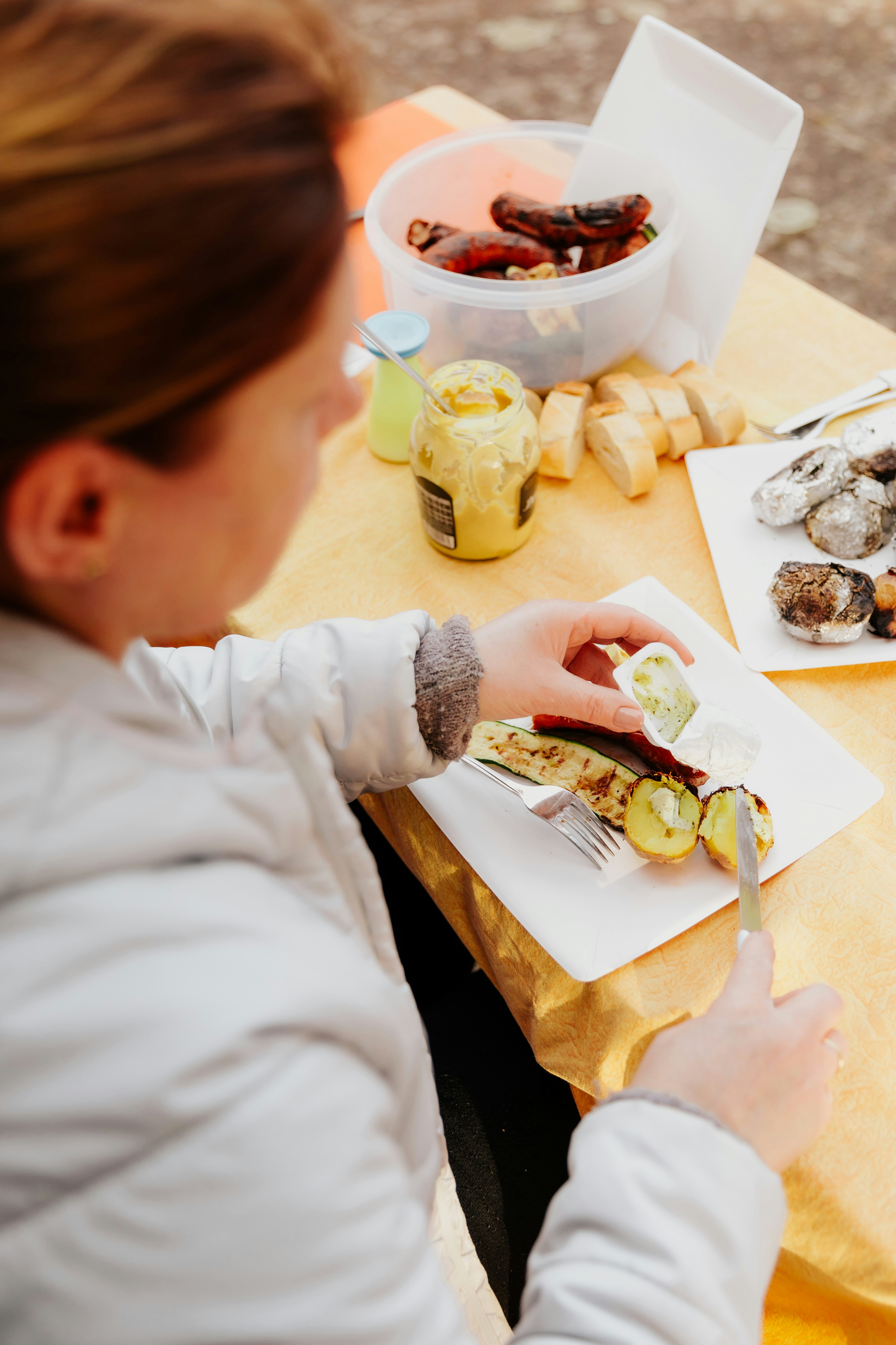 Over-the-Shoulder Brunch: A sunlit spread of bread, mustard, and pastries