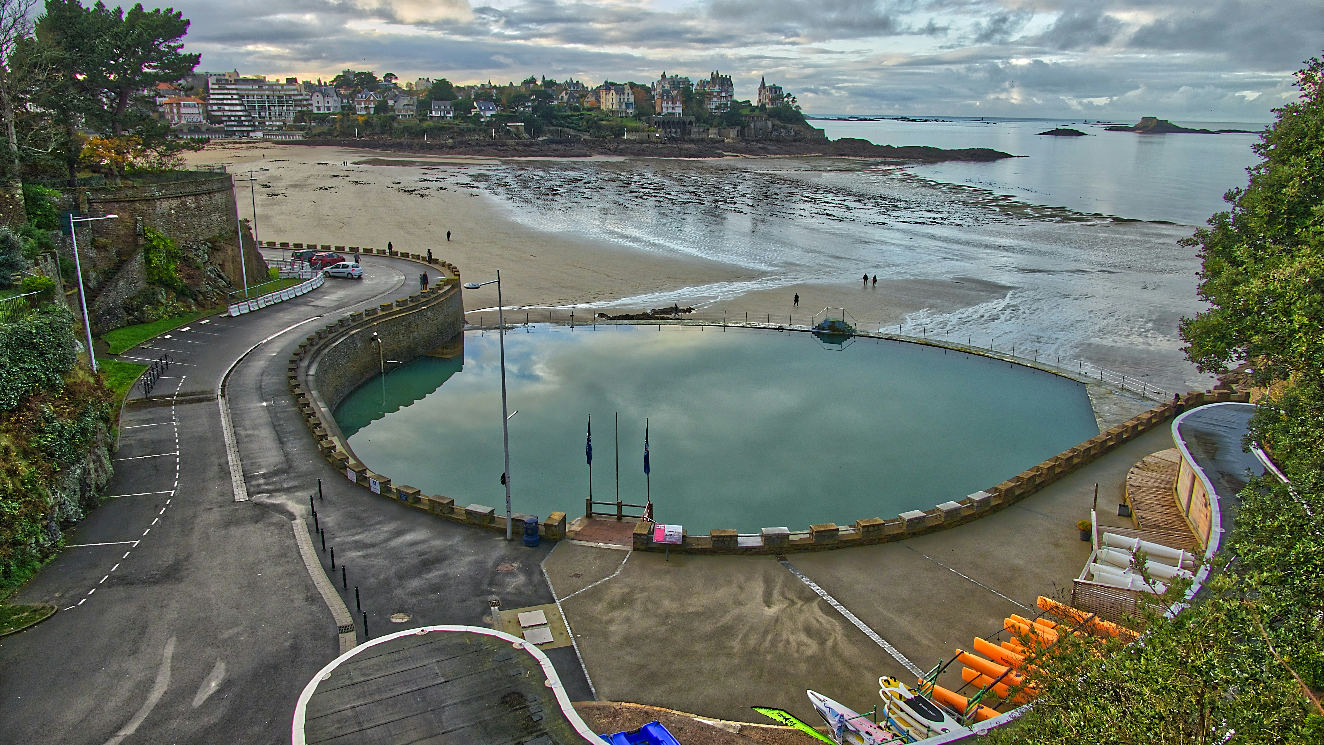 Harbor Basin at Distant Shore: Circular Pool Meets B Each Wall in a Quiet Tide