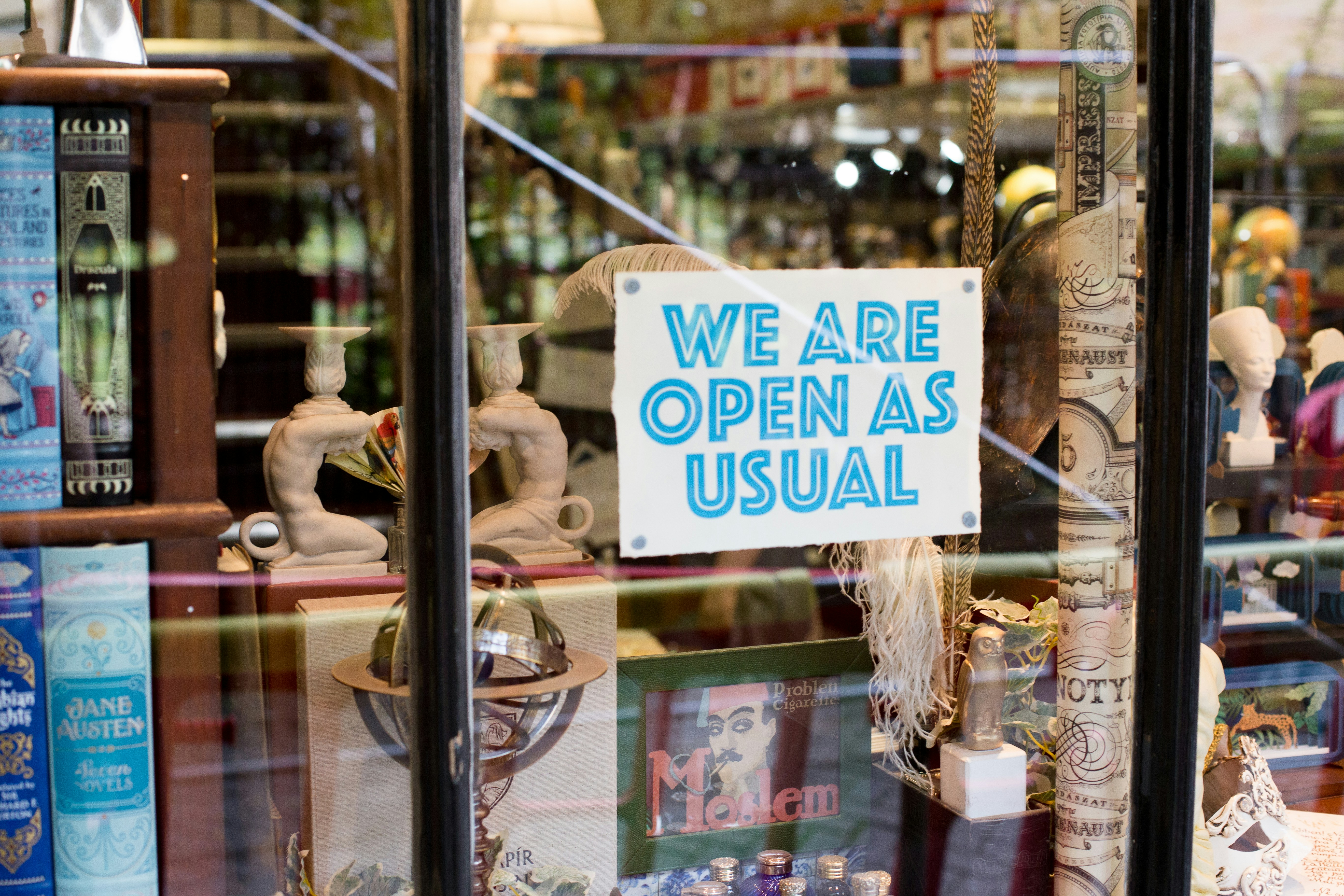 We Are Open as Usual: A Glass-Front Shop Window Full of Objects