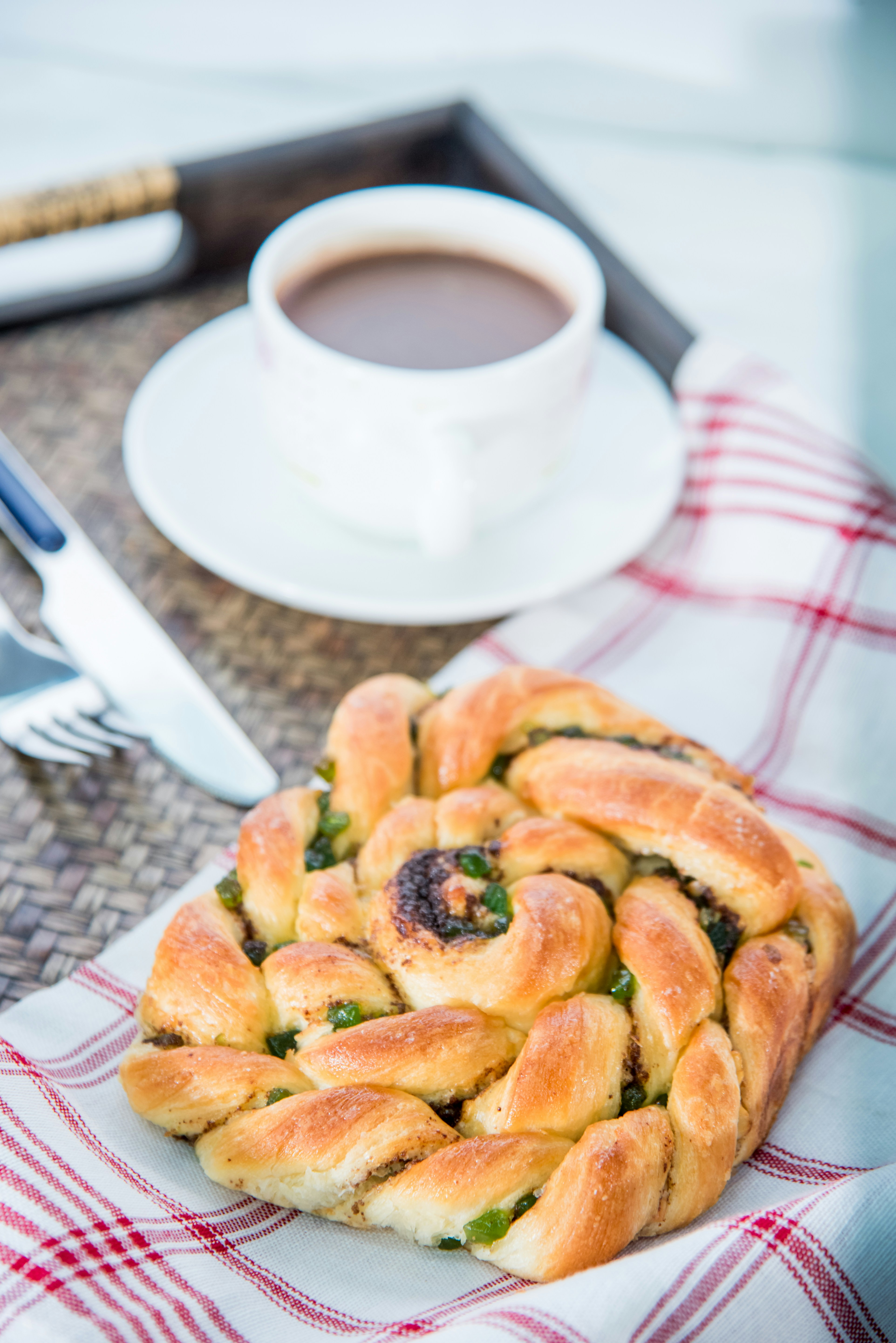 Braided Savory Pastry Graced by Morning Coffee on Checkered Cloth