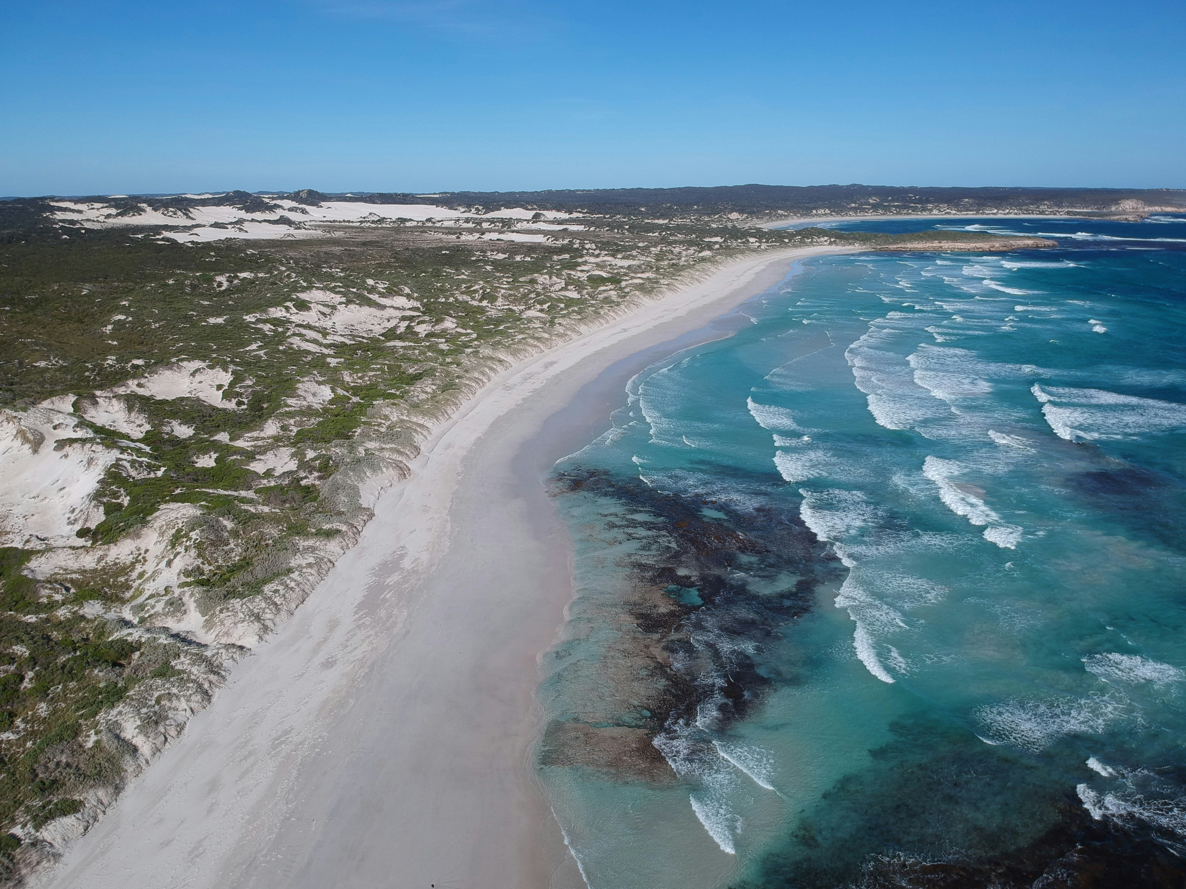 Body of water under blue sky during daytime photo – Free Grey Image on ...