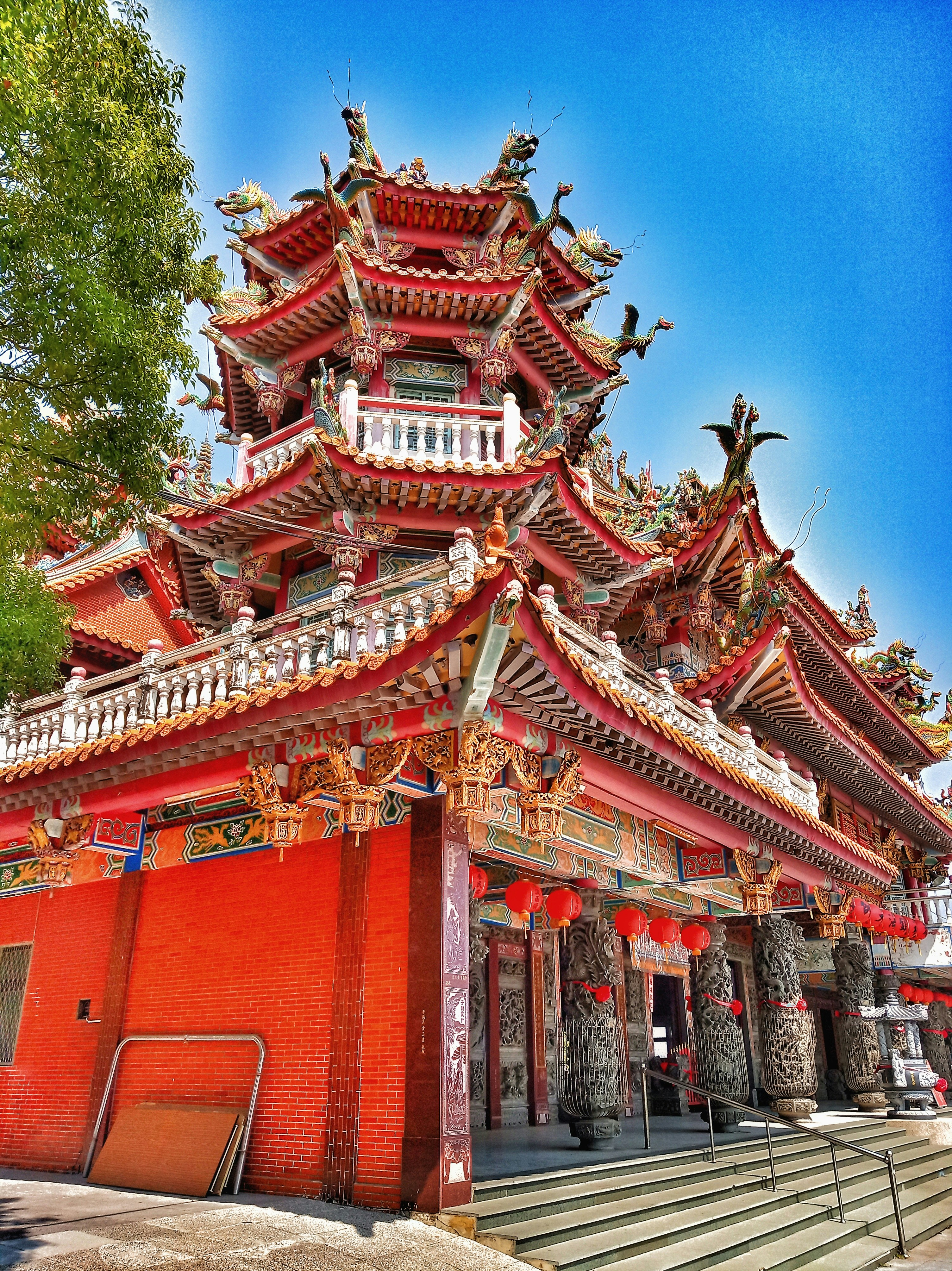 Intricate temple structure adorned with colorful details and lanterns, showcasing traditional craftsmanship and cultural significance.