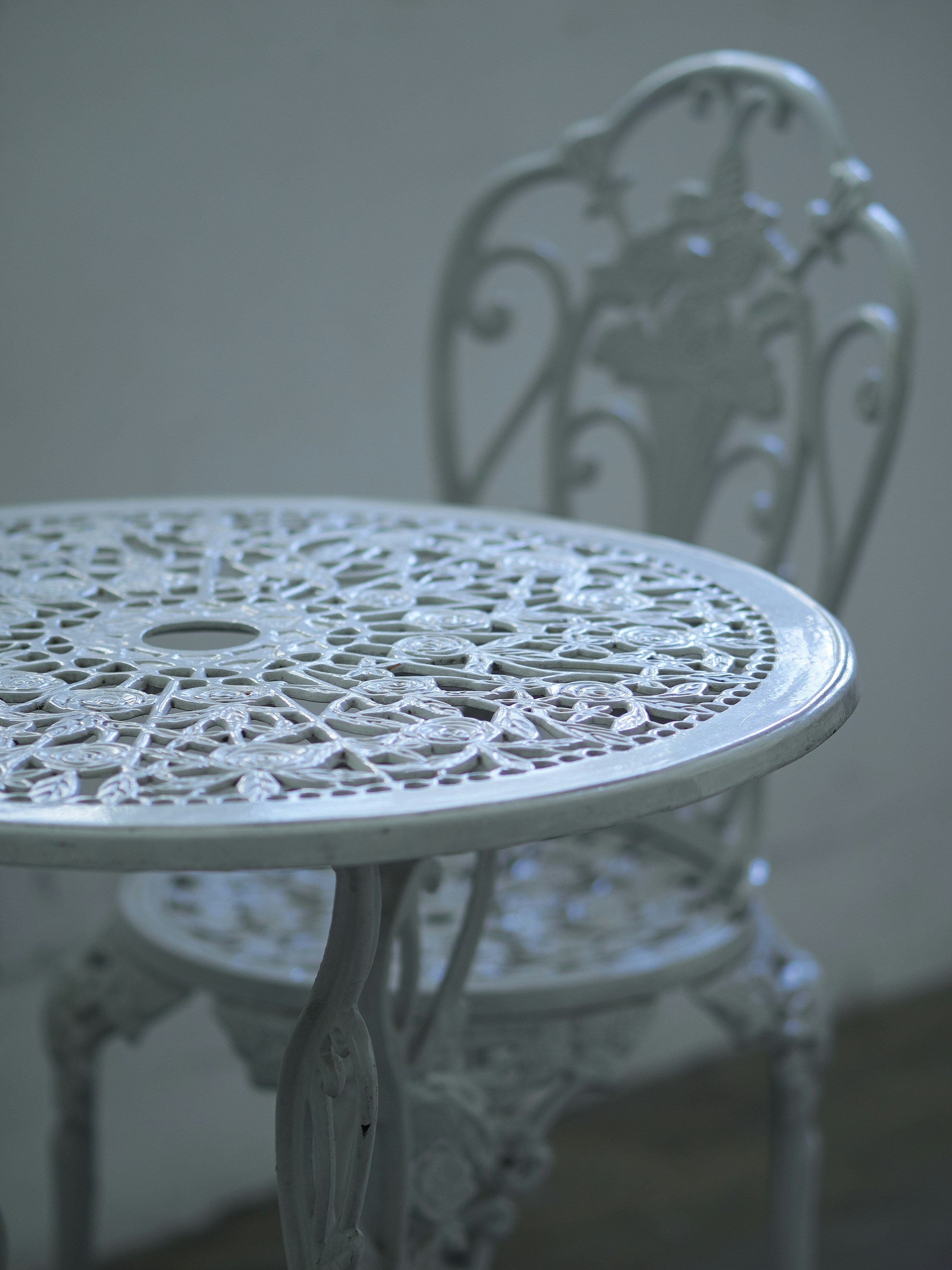 Lacework in the Light: A White Iron Table Close-Up