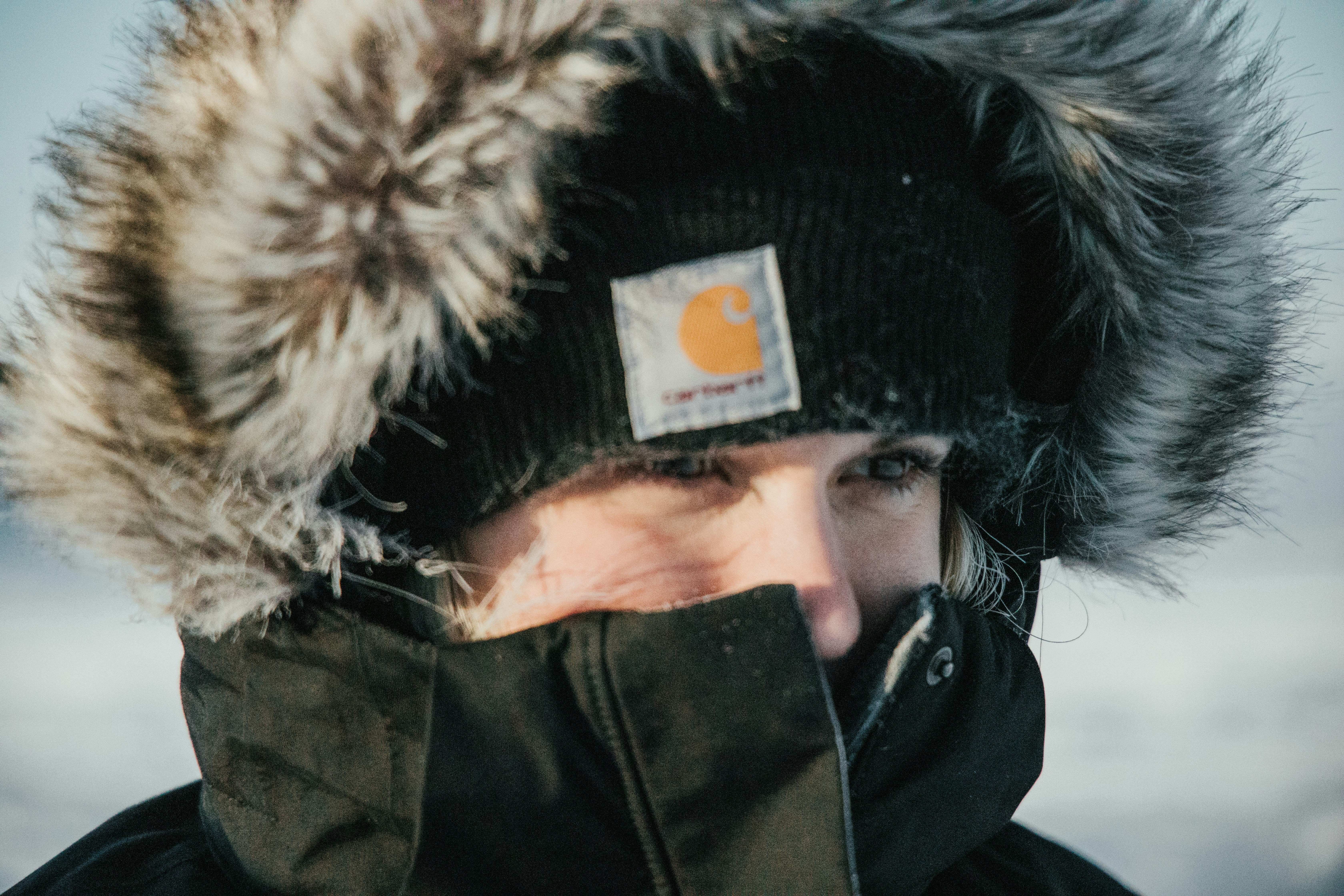 Frost-Lit Gaze: Close Portrait Under a Fur-Trimmed Winter Hood