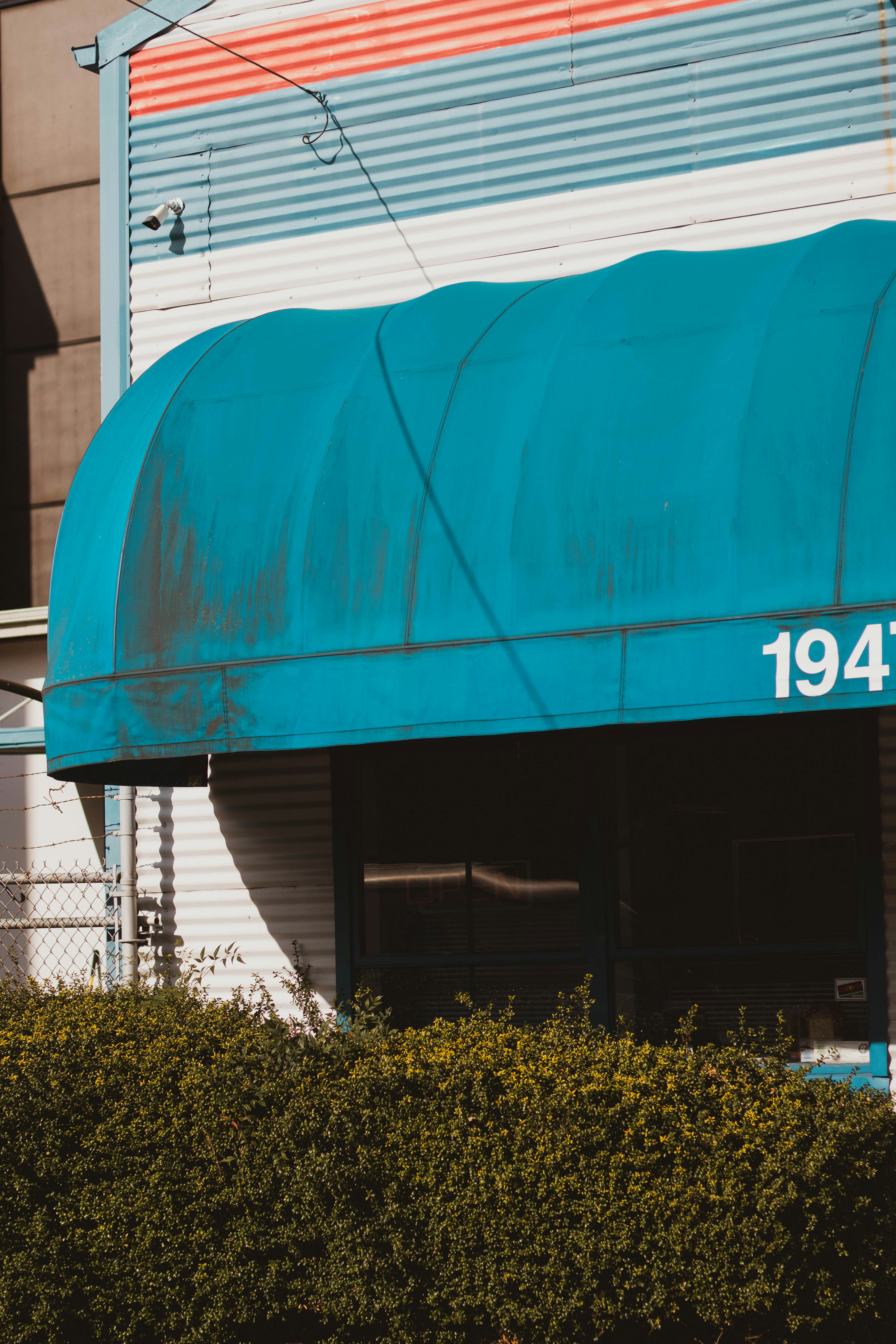 Teal Canopy, Striped Facade: A Quiet Storefront Moment