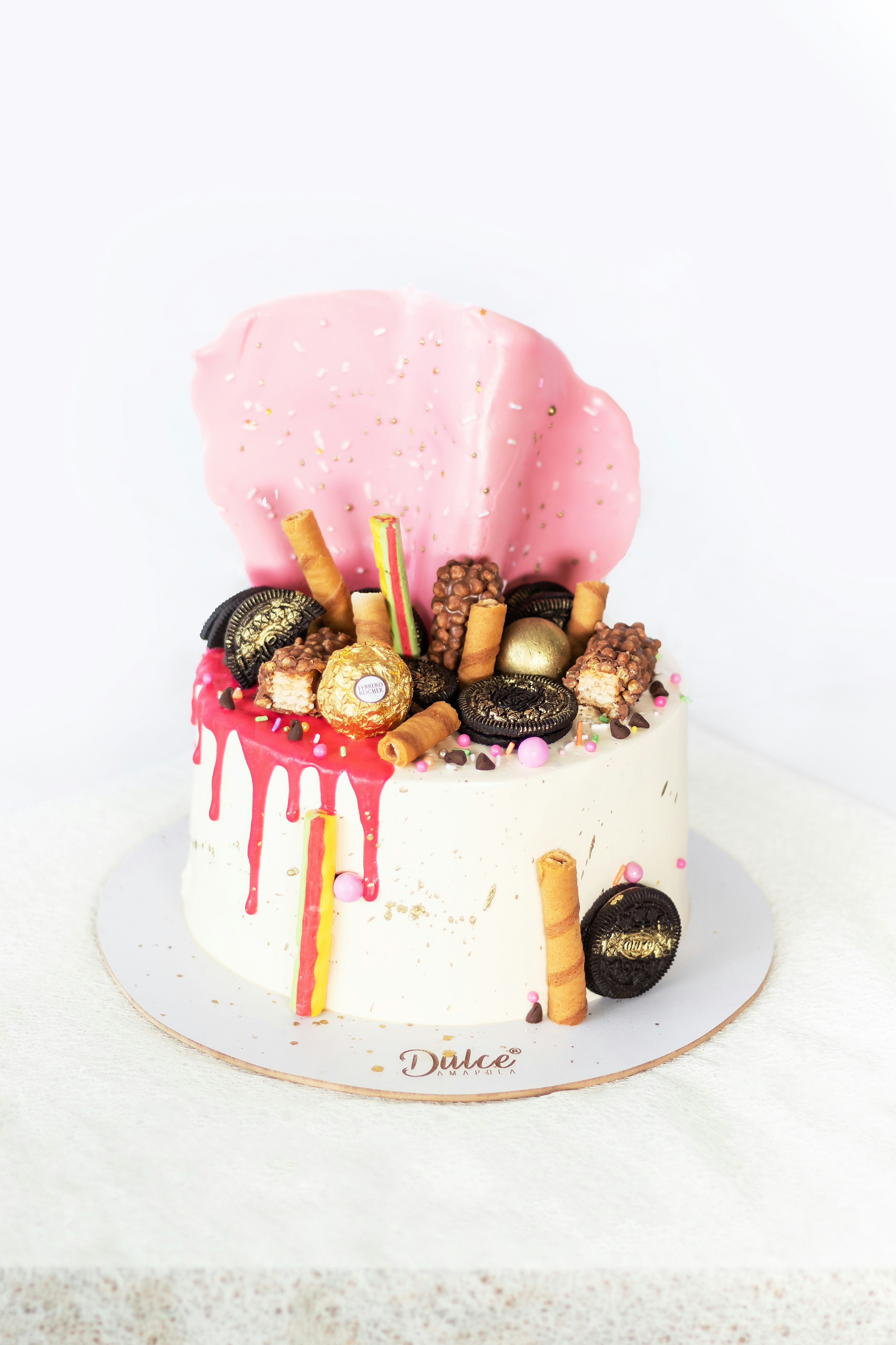 Pink Drip Crown: A Dessert Cake Adorned with Cookies and Candy Wands