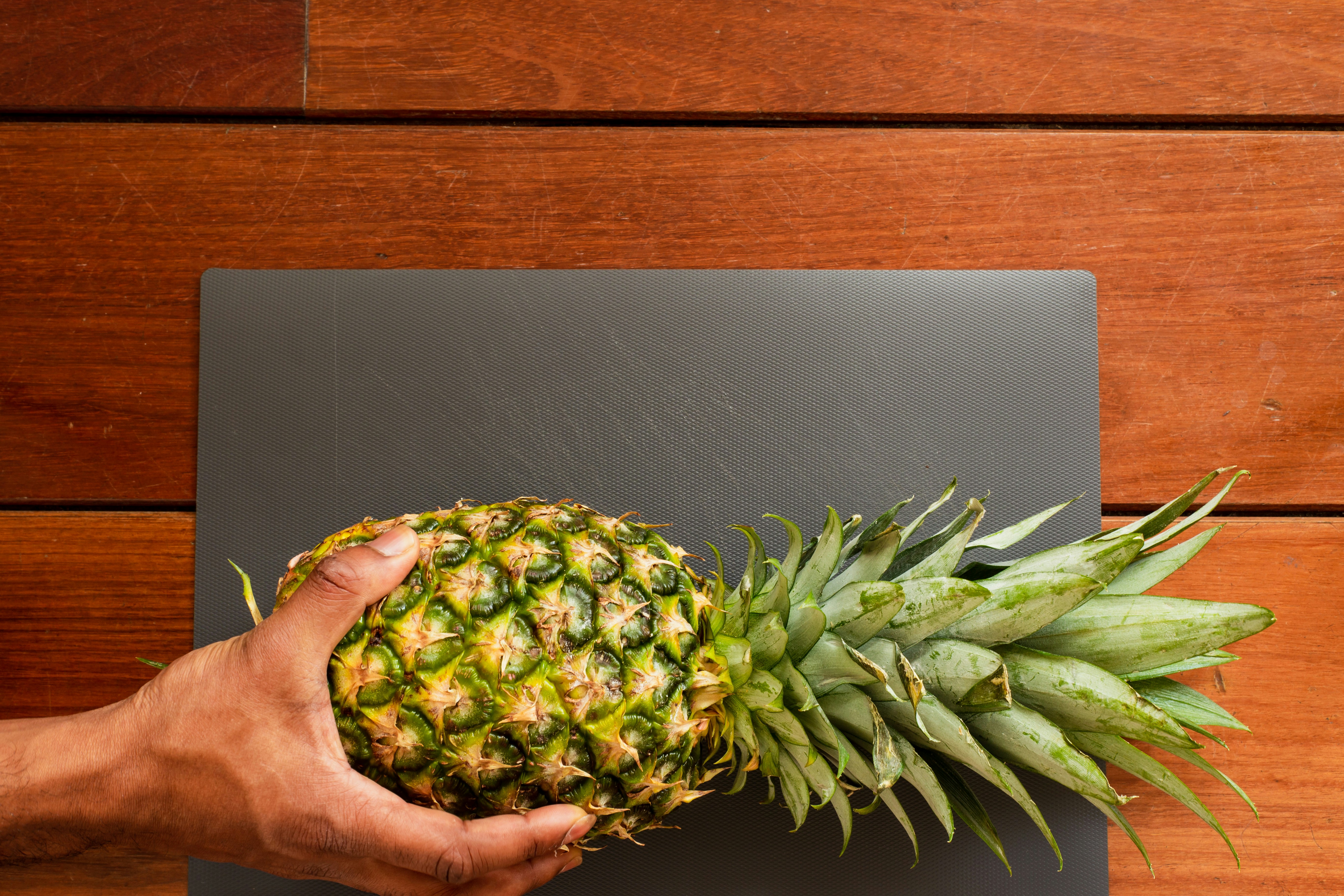 Grip and Crown: Pineapple Still Life on a Wooden Table
