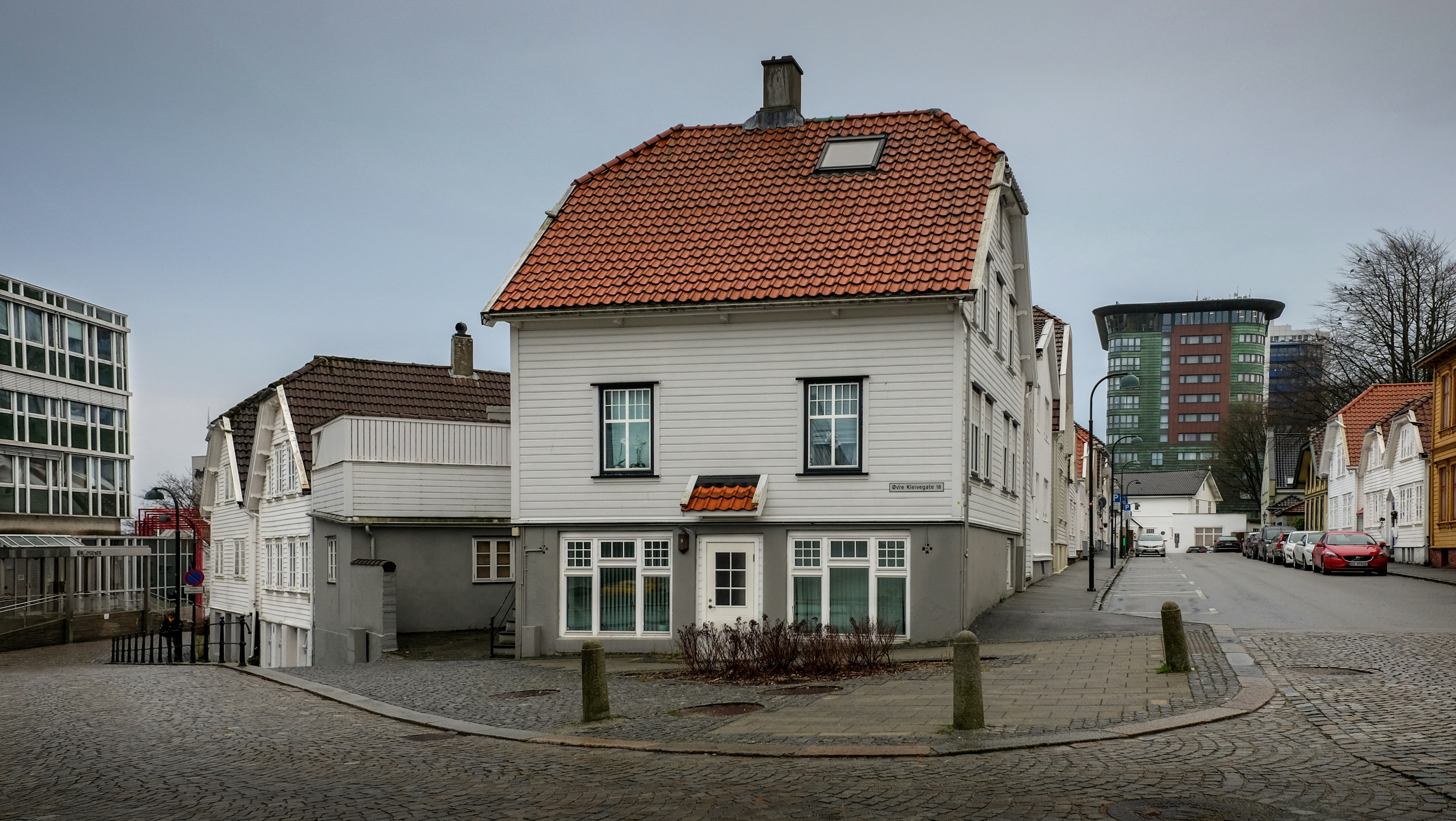 Cobbled Crossroads: A White House with a Bold Red Roof