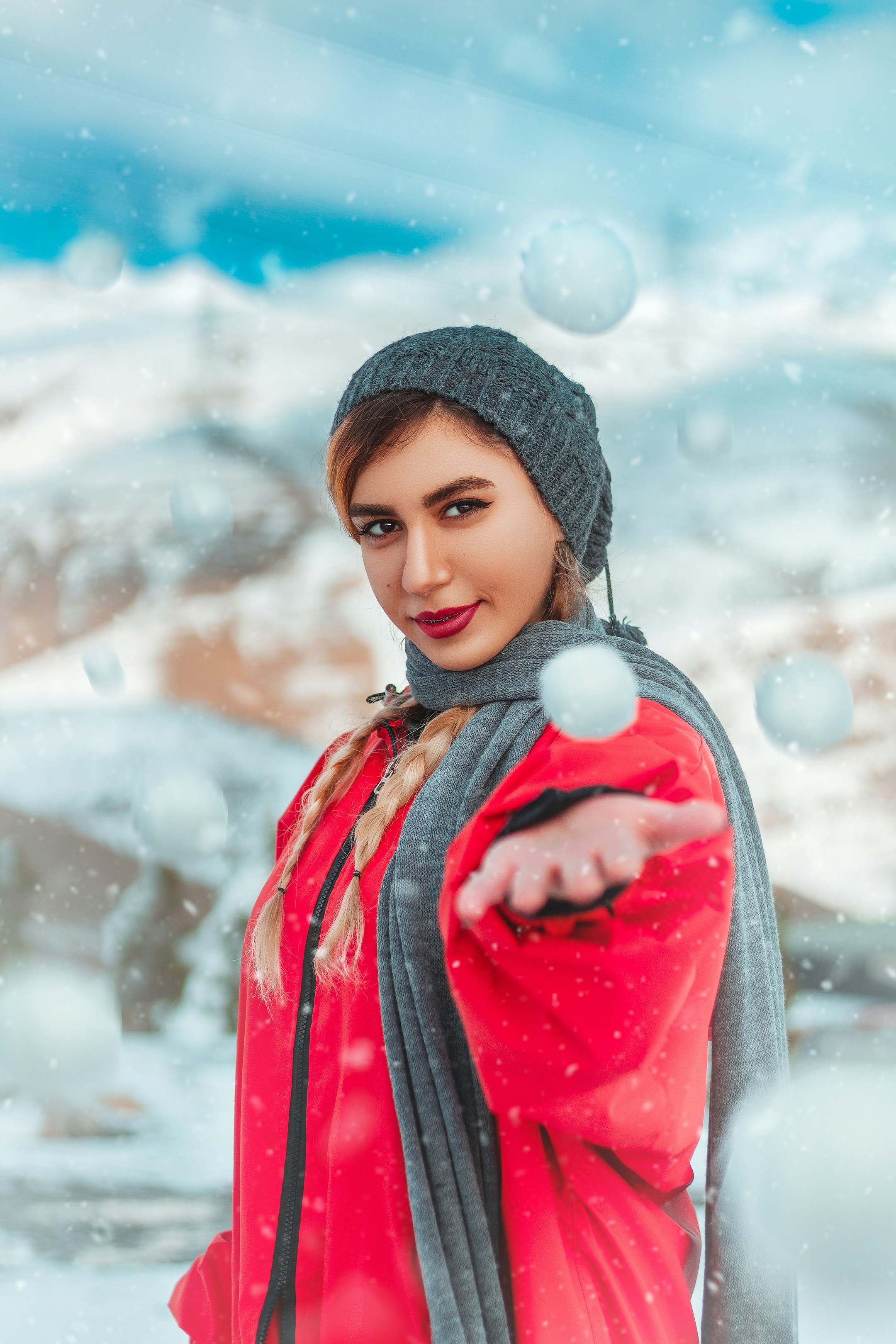 girl in red and black jacket and black knit cap