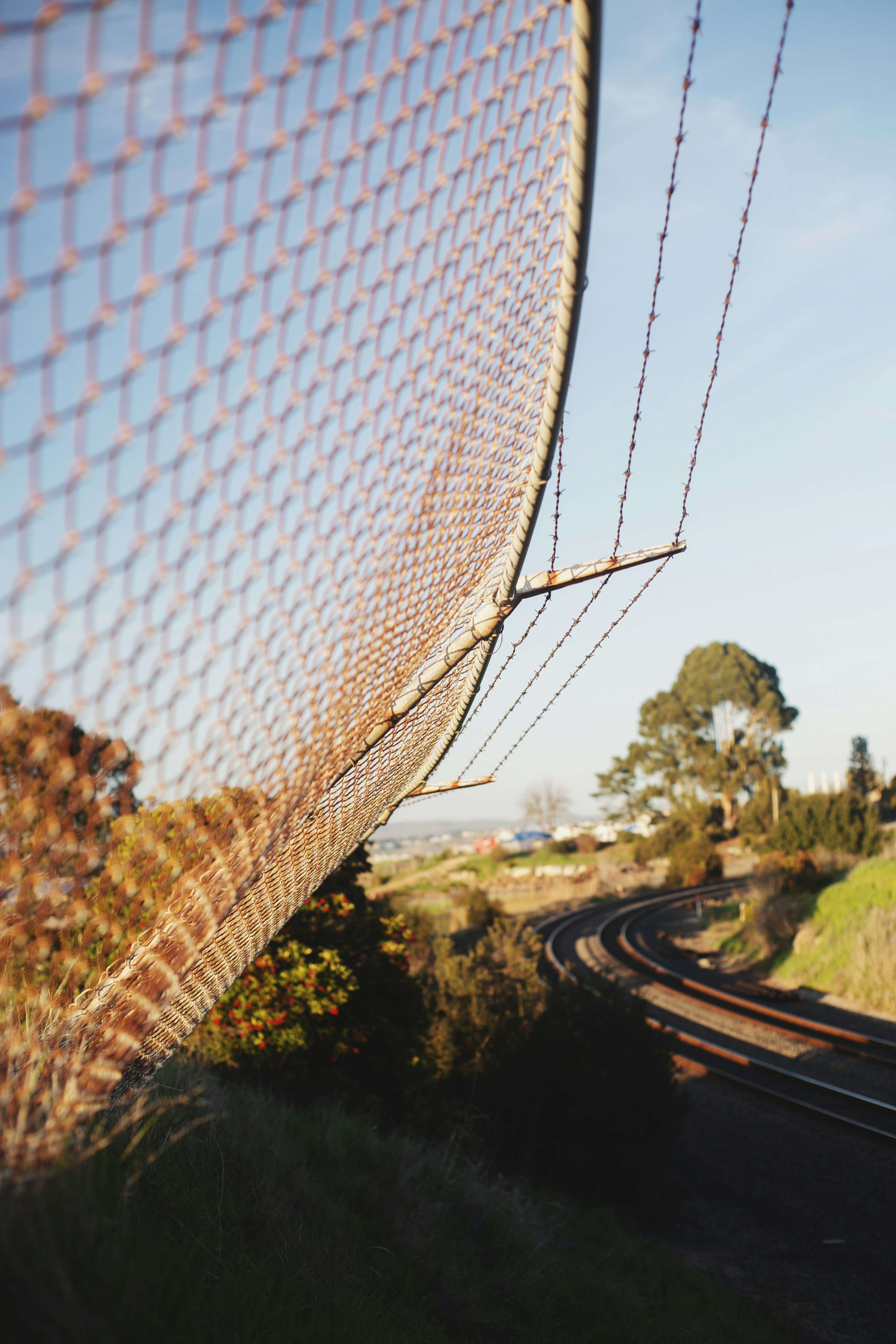 Chain-link Boundary: A Quiet Bend by the Rails