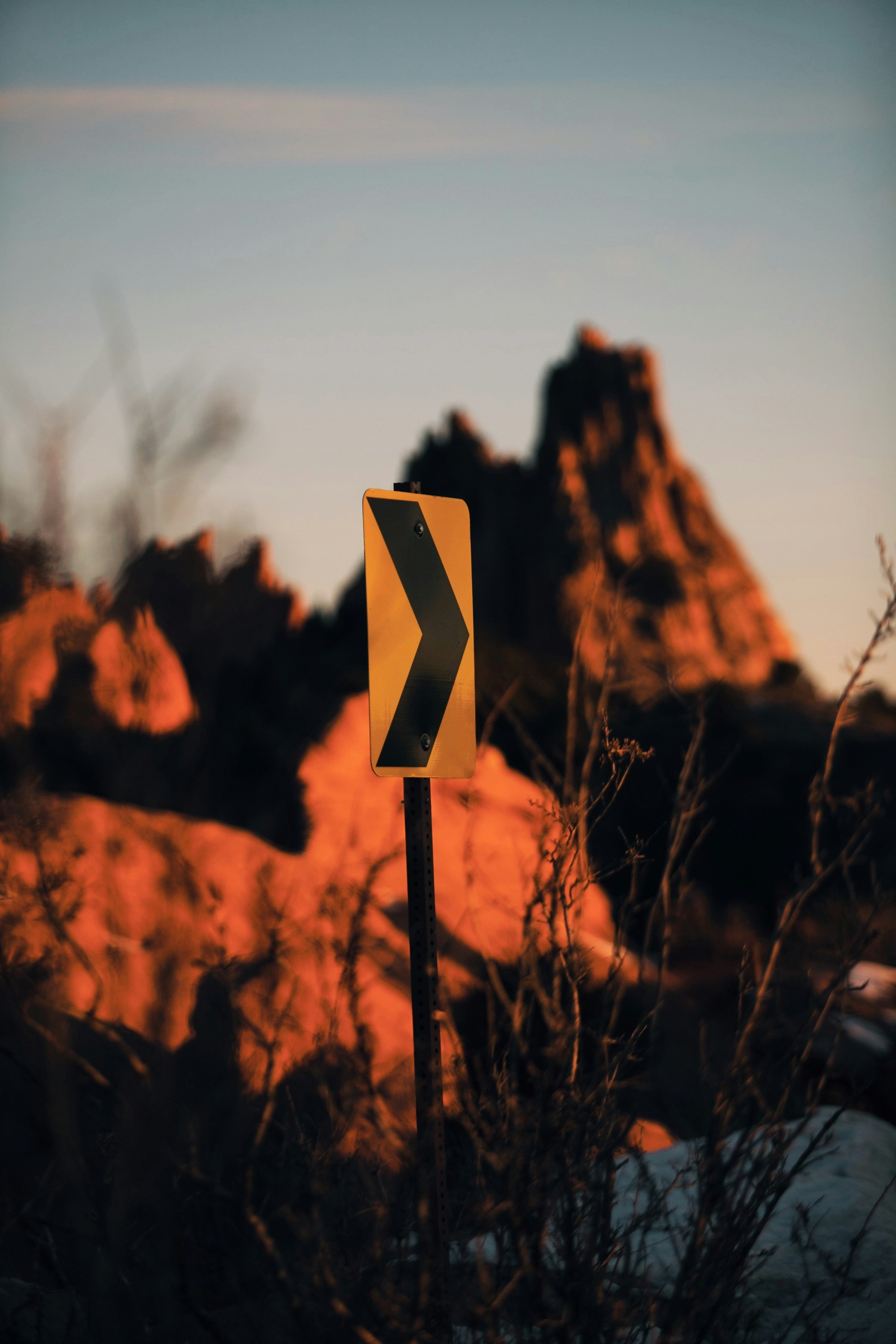 Golden Hour Chevron: Lone Sign Beside Sunset-Rose Rock Formations