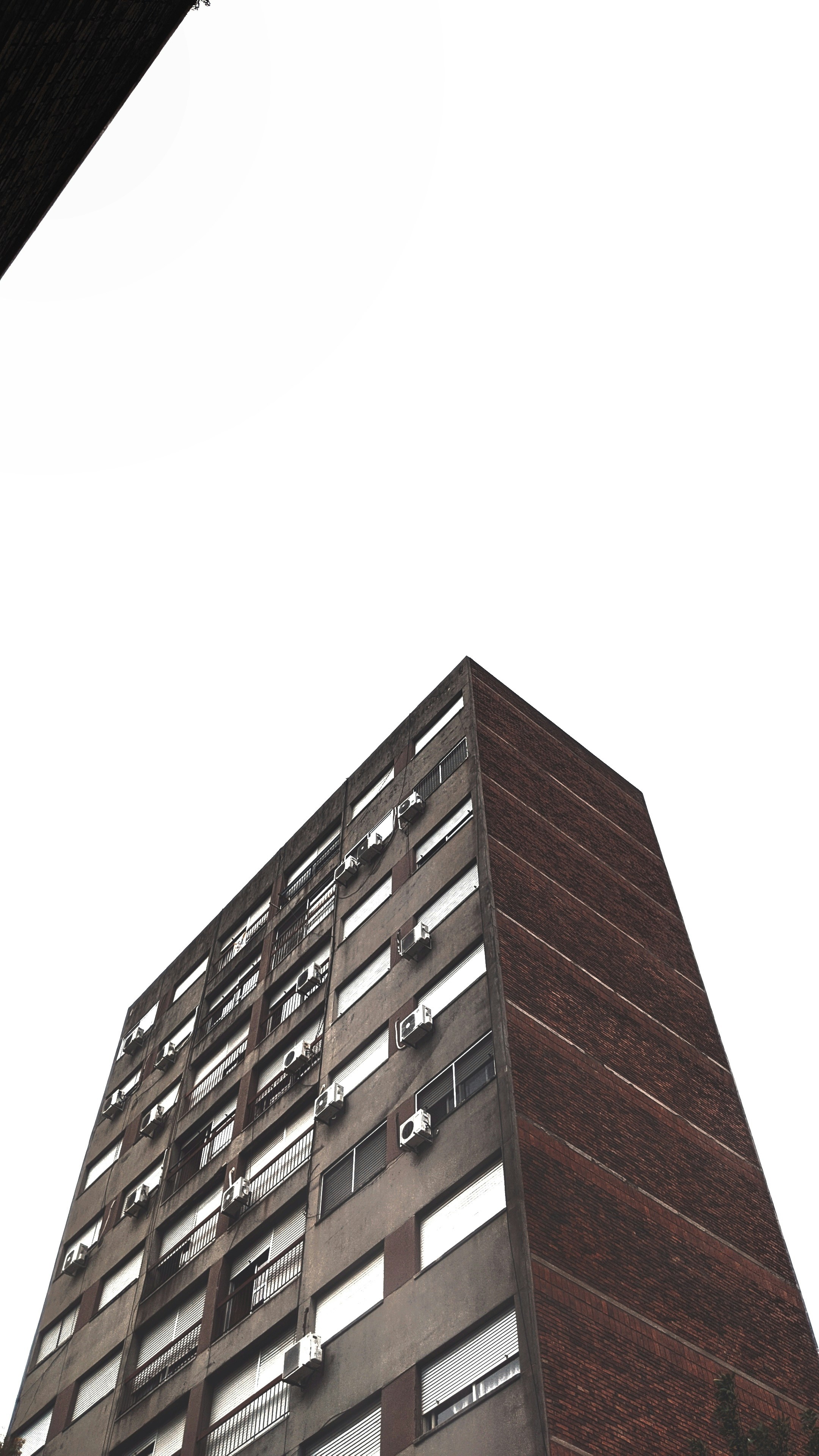 Urban Lean: A Rooftop Perspective of a Brick Facade