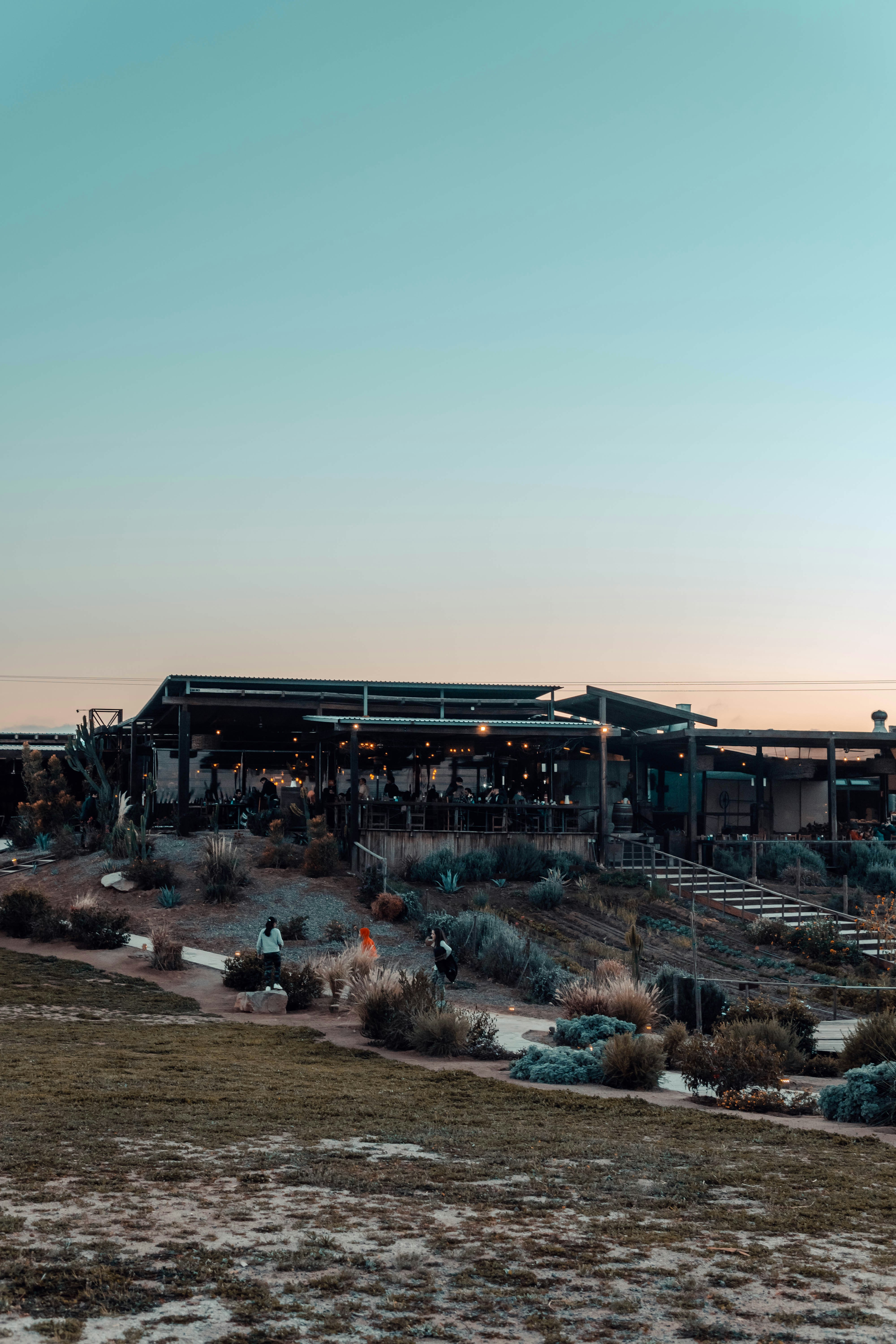 Desert Terrace Dusk: Warm Lights Over a Hillside Bistro