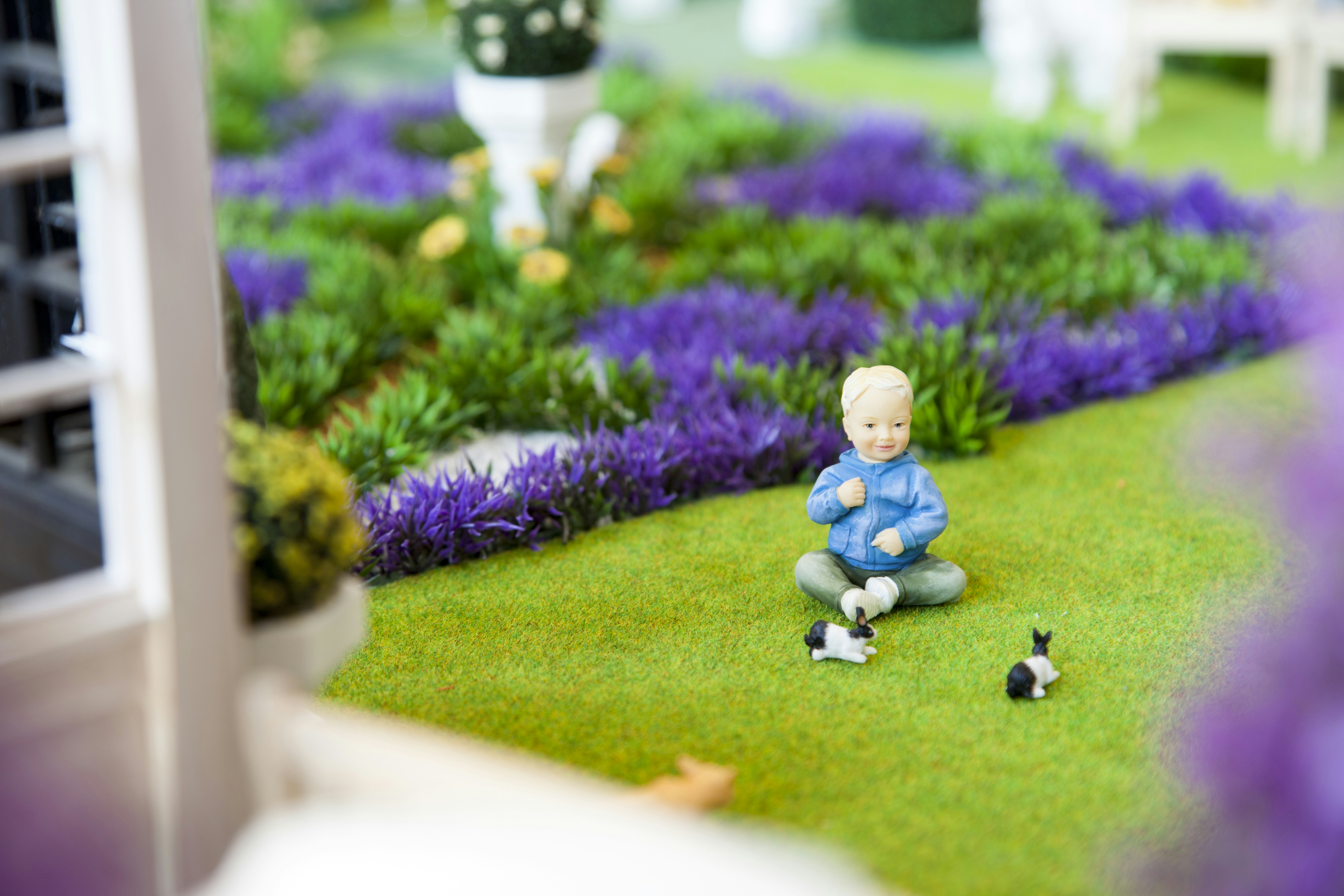 Blue-Robed Child Figurine Guards a Miniature Lavender Garden
