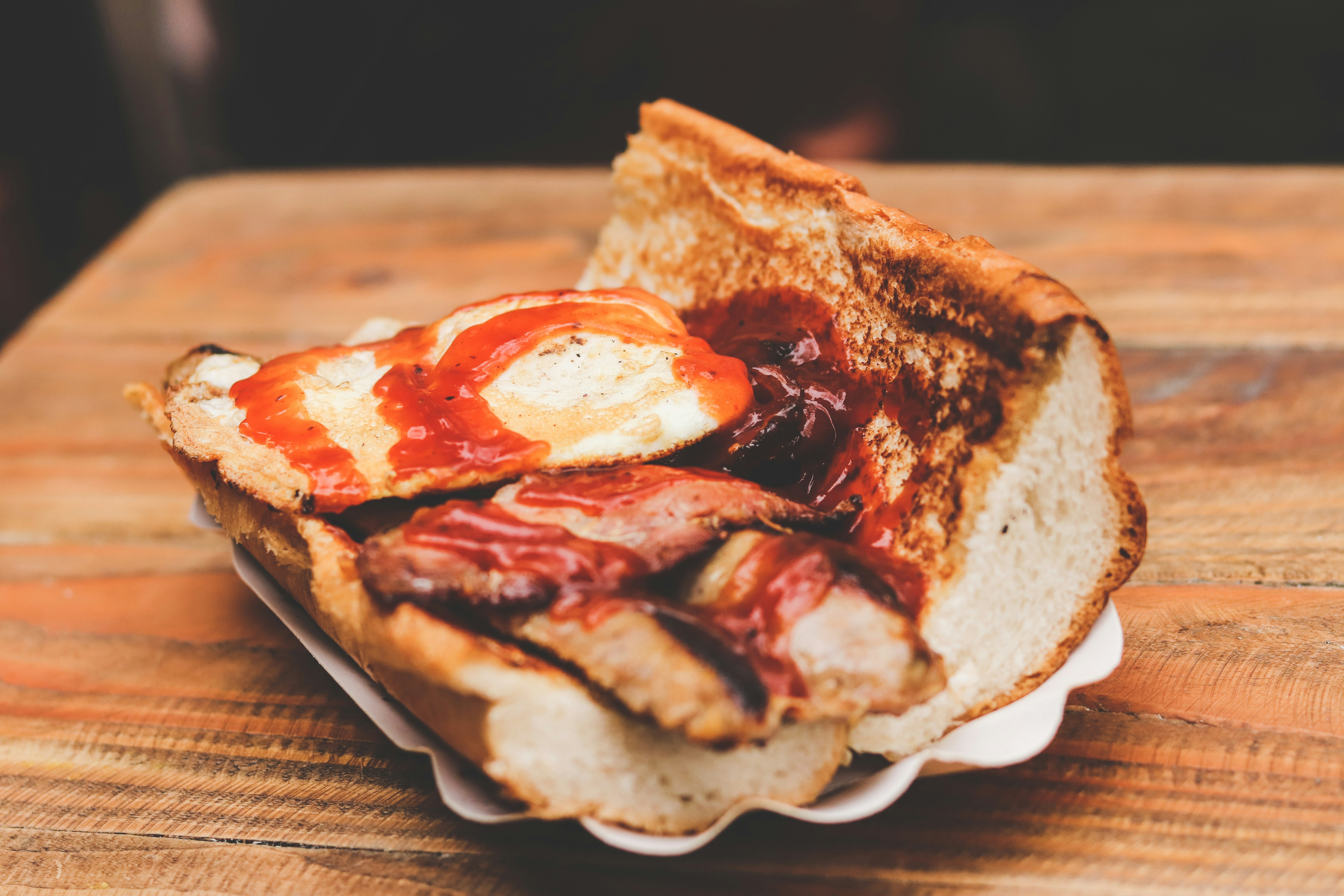 Bread with red sauce on brown wooden table photo – Free Bread Image on ...