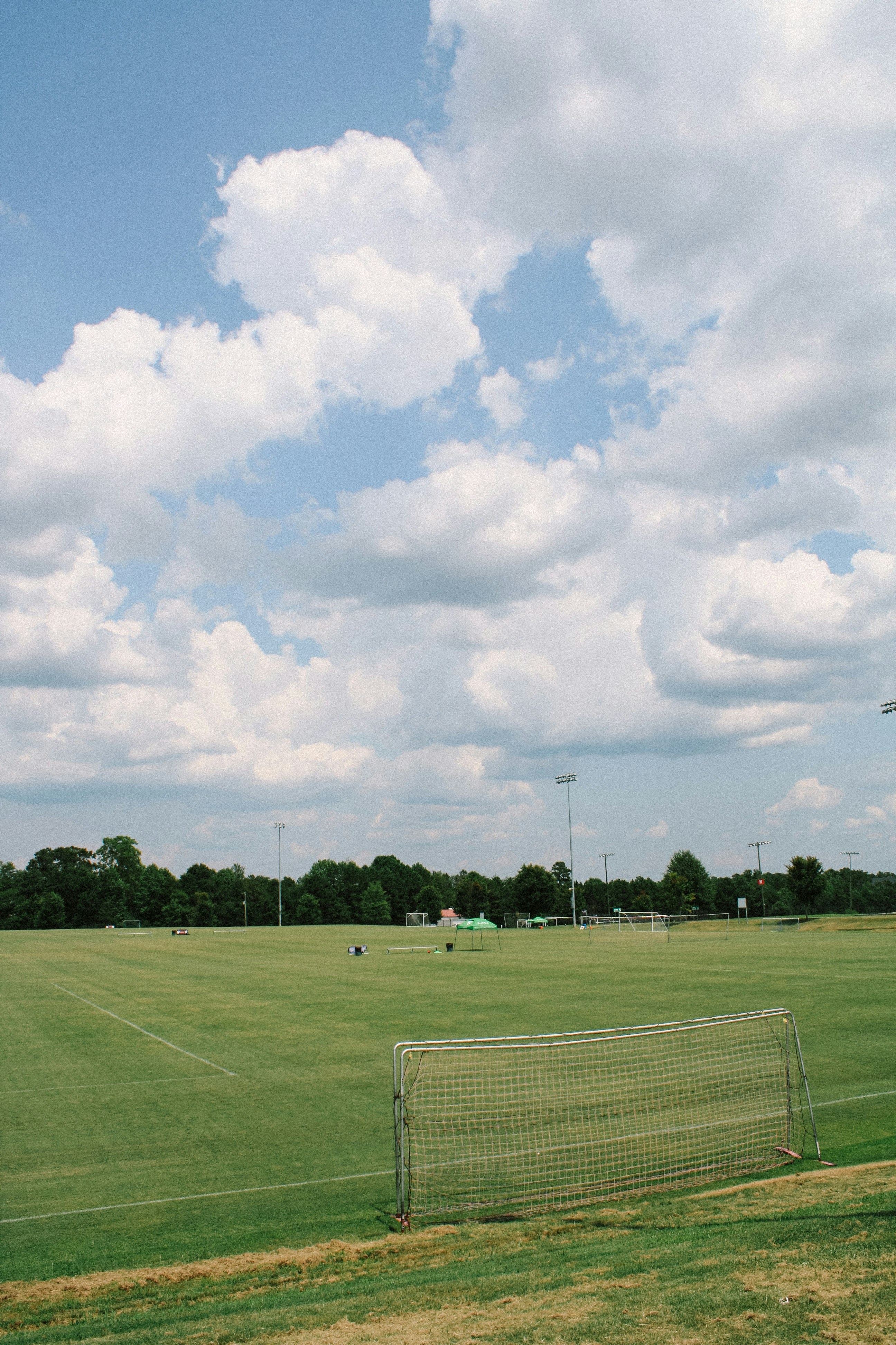 A Quiet Field Under Puffy Skies: Soccer Goal in the Foreground