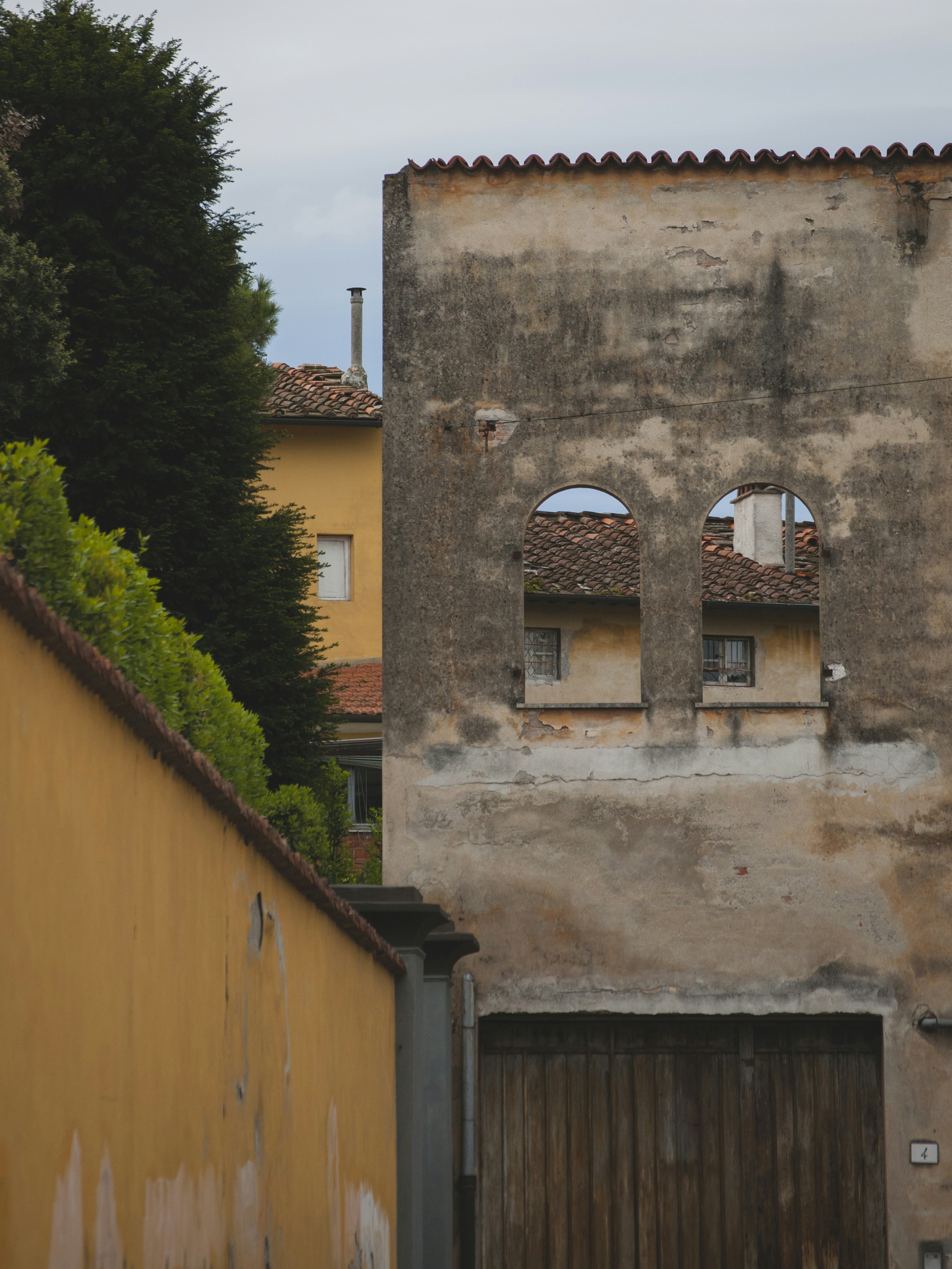 brown concrete building near green trees during daytime